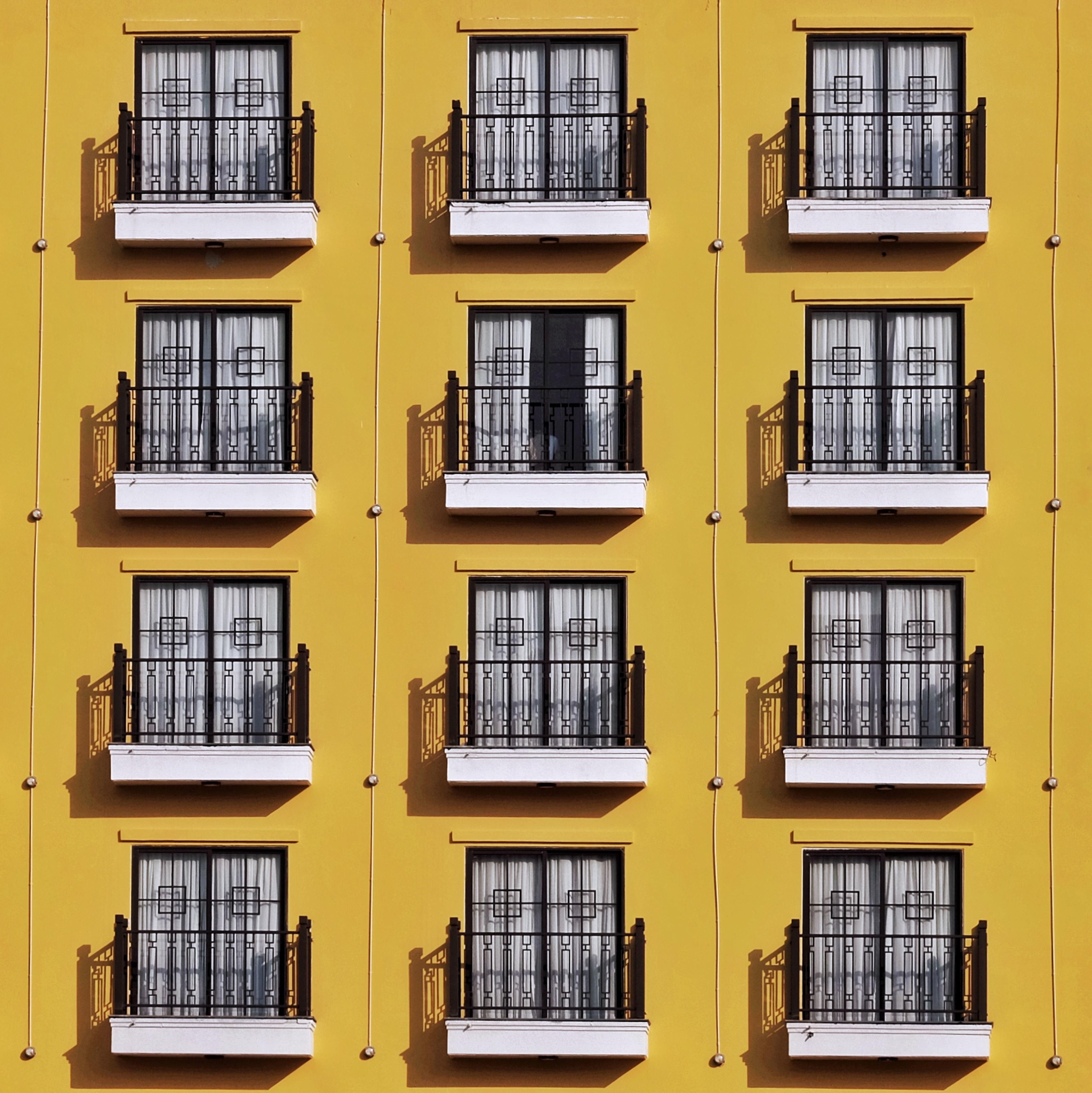 Architectural Photography of Three Pink, Blue, and Yellow Buildings ...