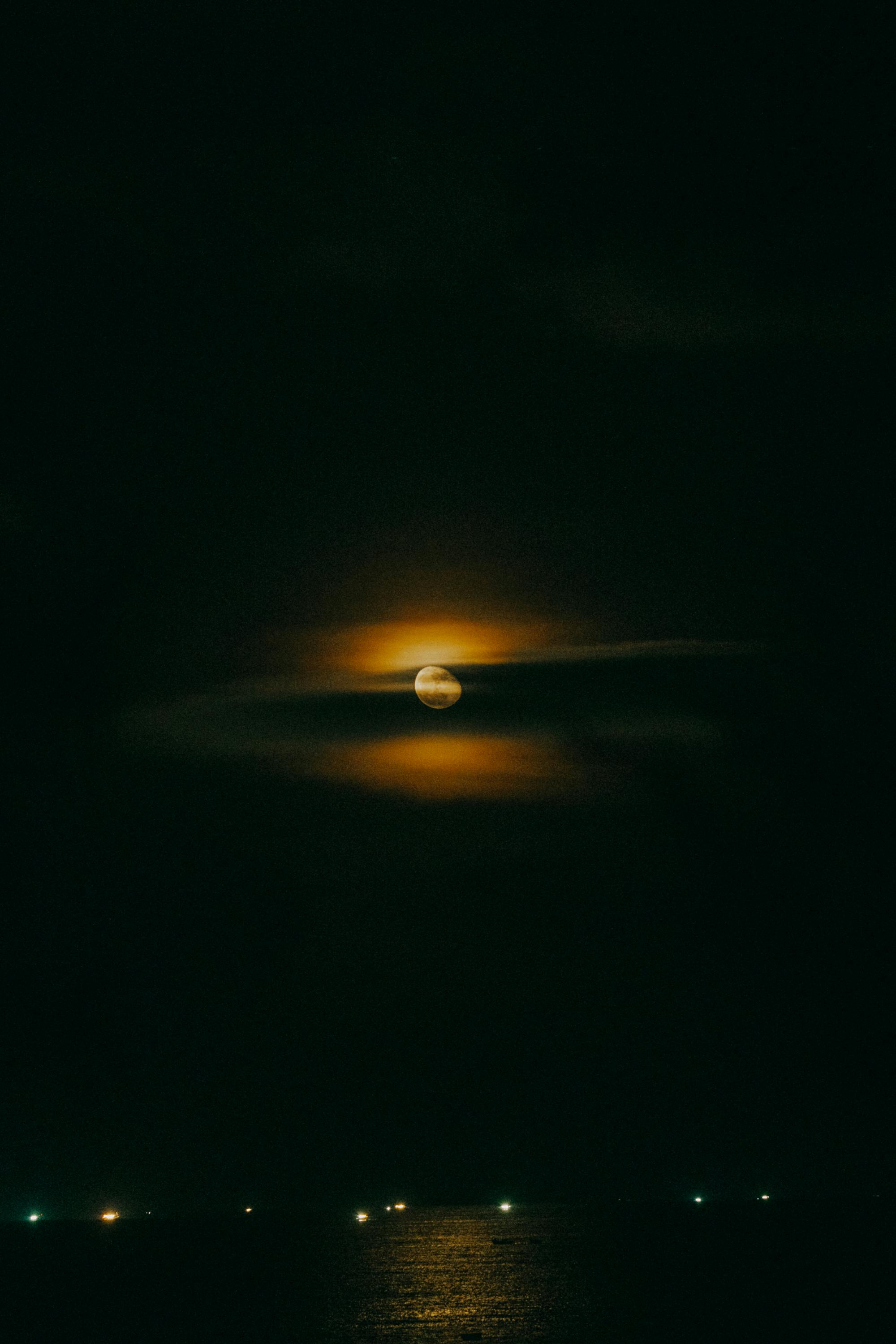 Full Moon behind a Cloud over the Sea · Free Stock Photo