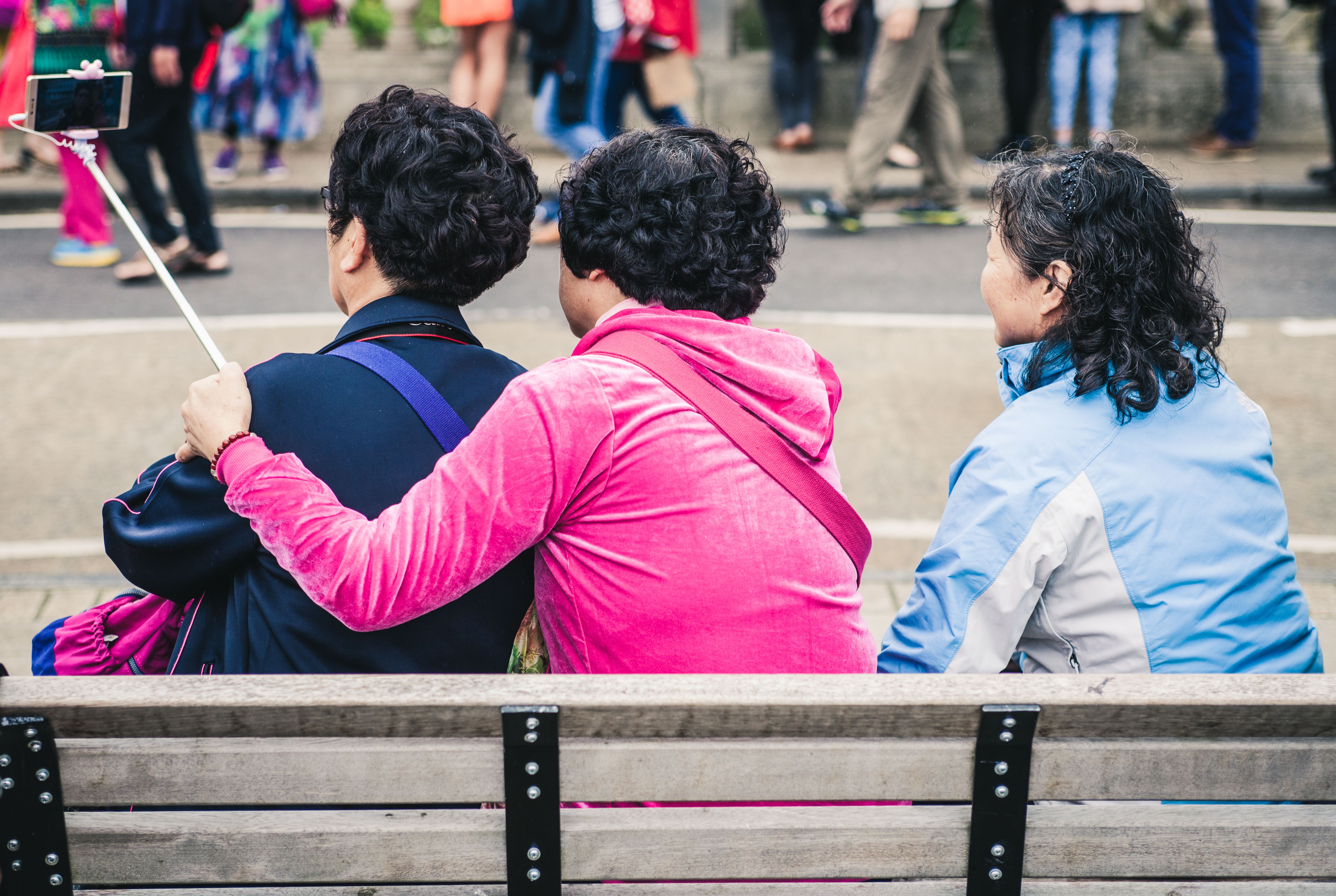 People Sitting on Bench Taking Photo · Free Stock Photo