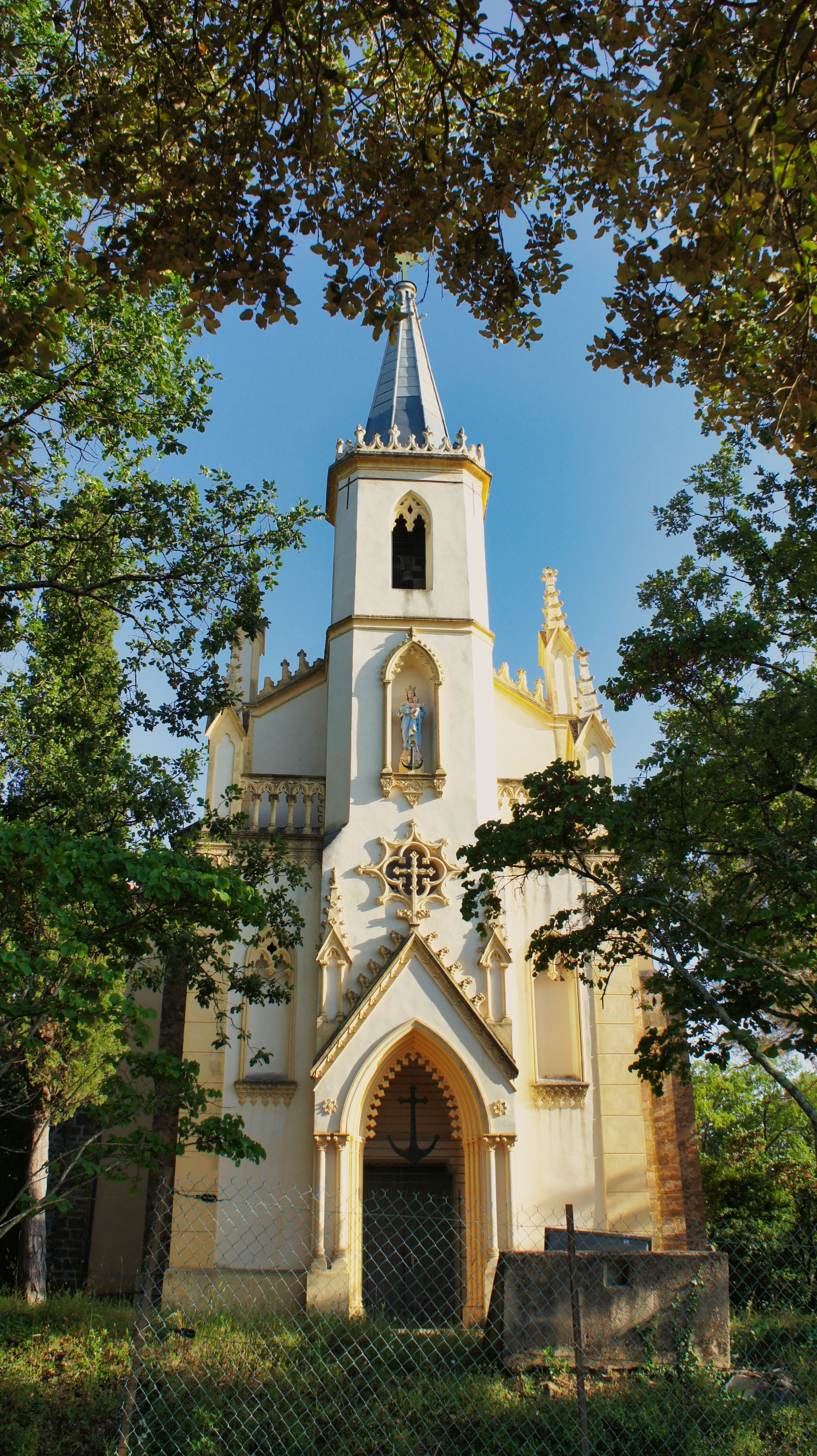 Facade of a Small Church Photographed from between Green Tree Branches ...