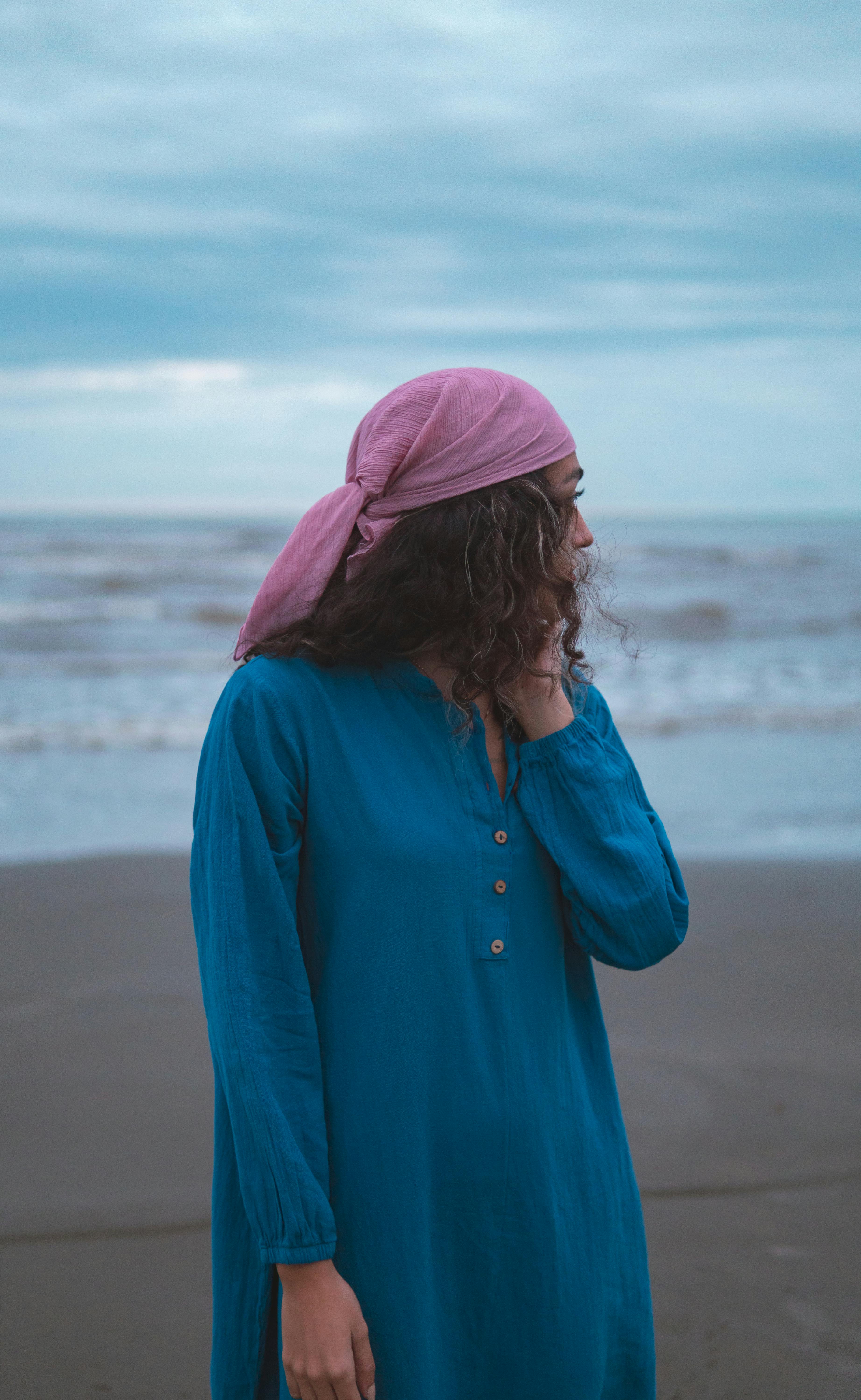 Woman in Blue Clothes Standing on Sea Shore · Free Stock Photo