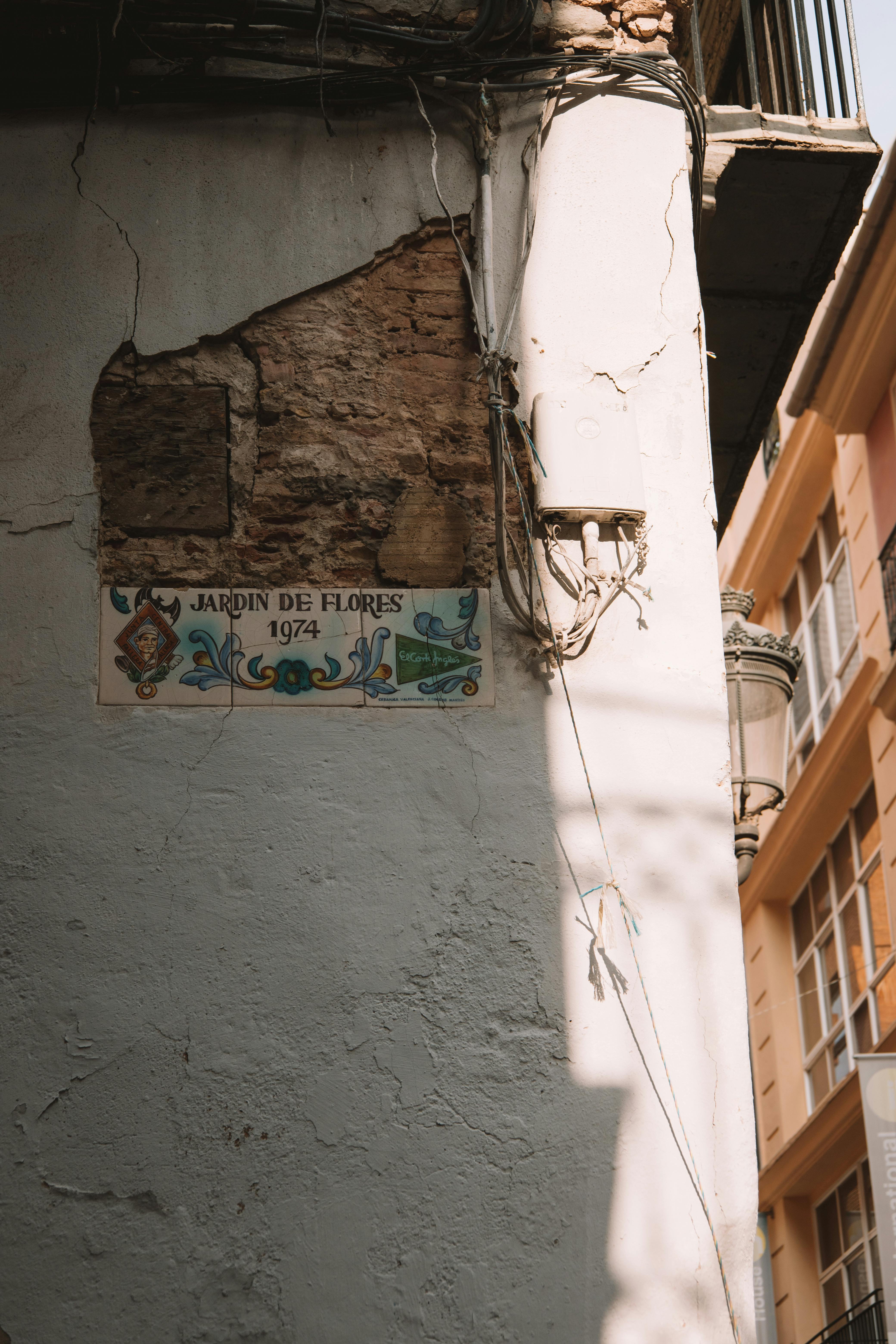 Decaying Sign on Old Building · Free Stock Photo