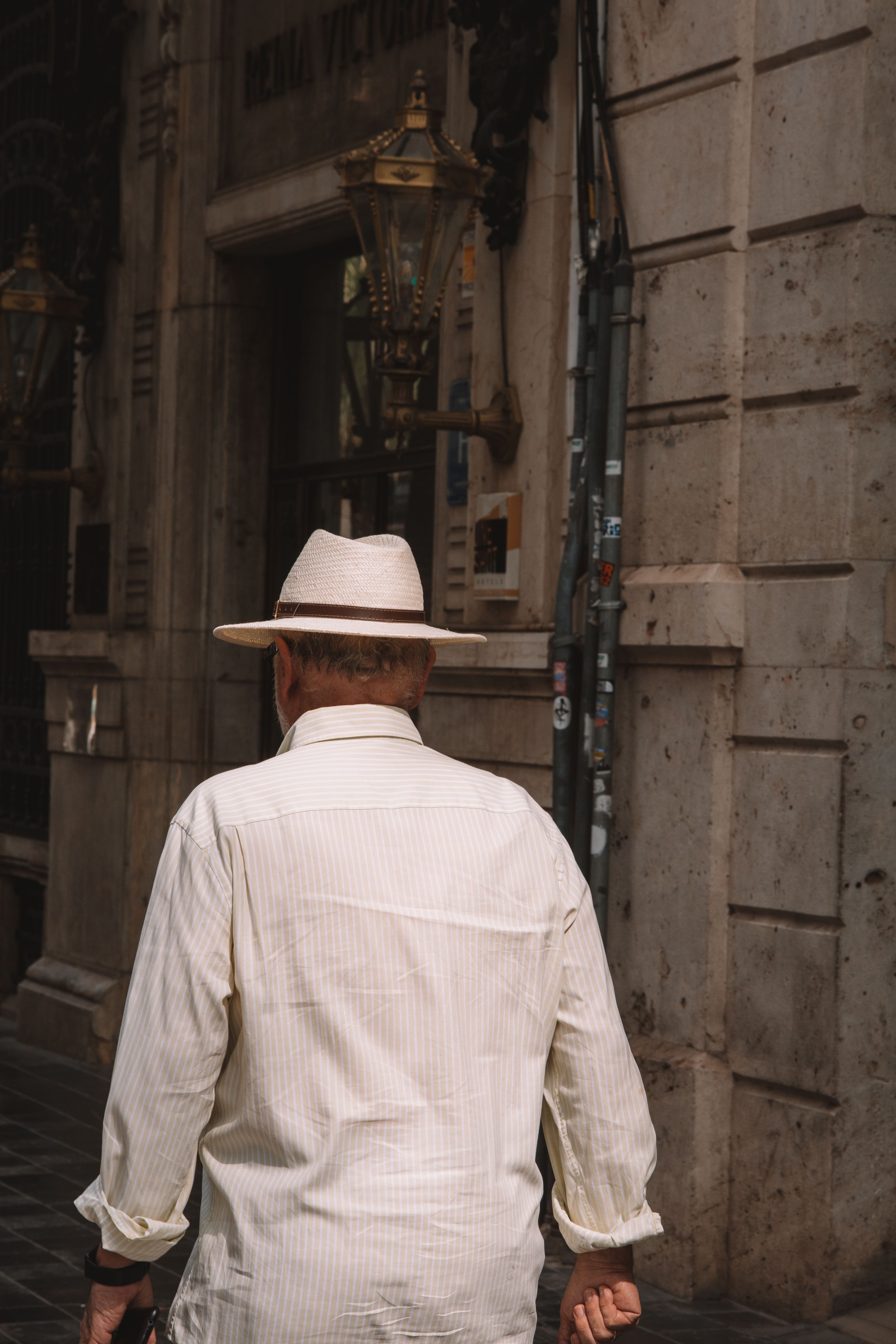 Man in Summer Fedora Walking on Street · Free Stock Photo