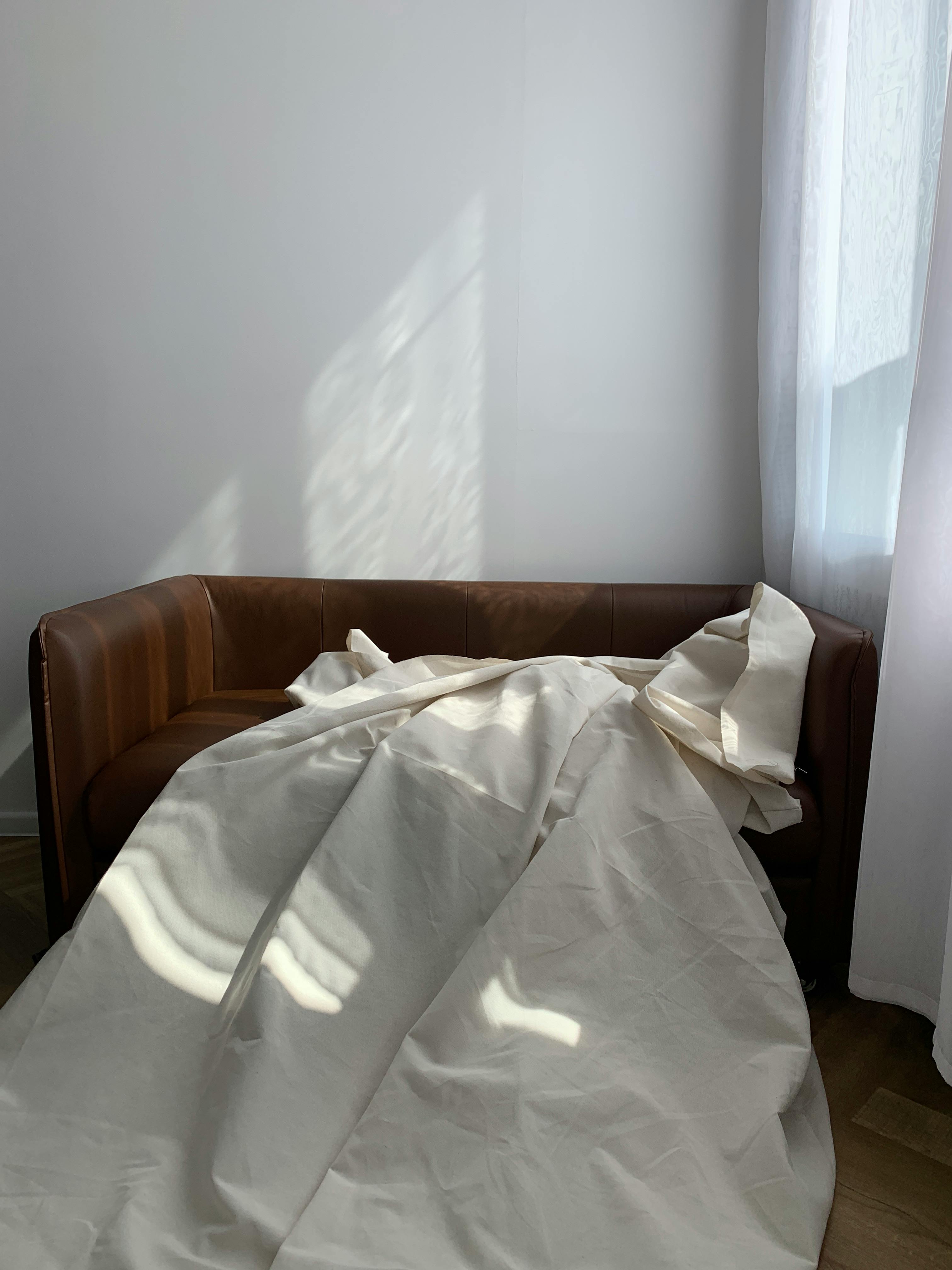 A Sheet of White Fabric on the Floor and Sofa · Free Stock Photo