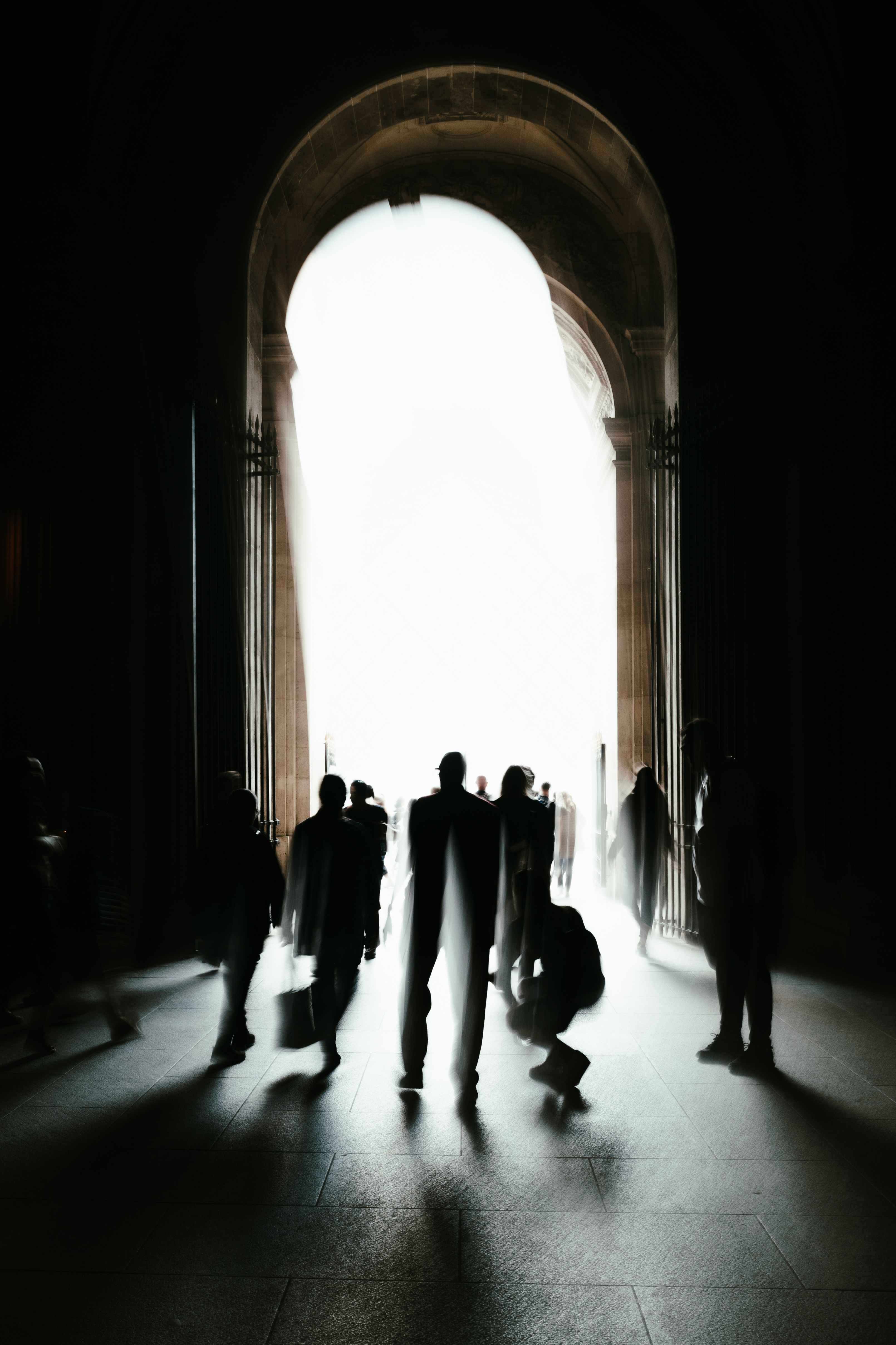 People Silhouettes Under Arch · Free Stock Photo