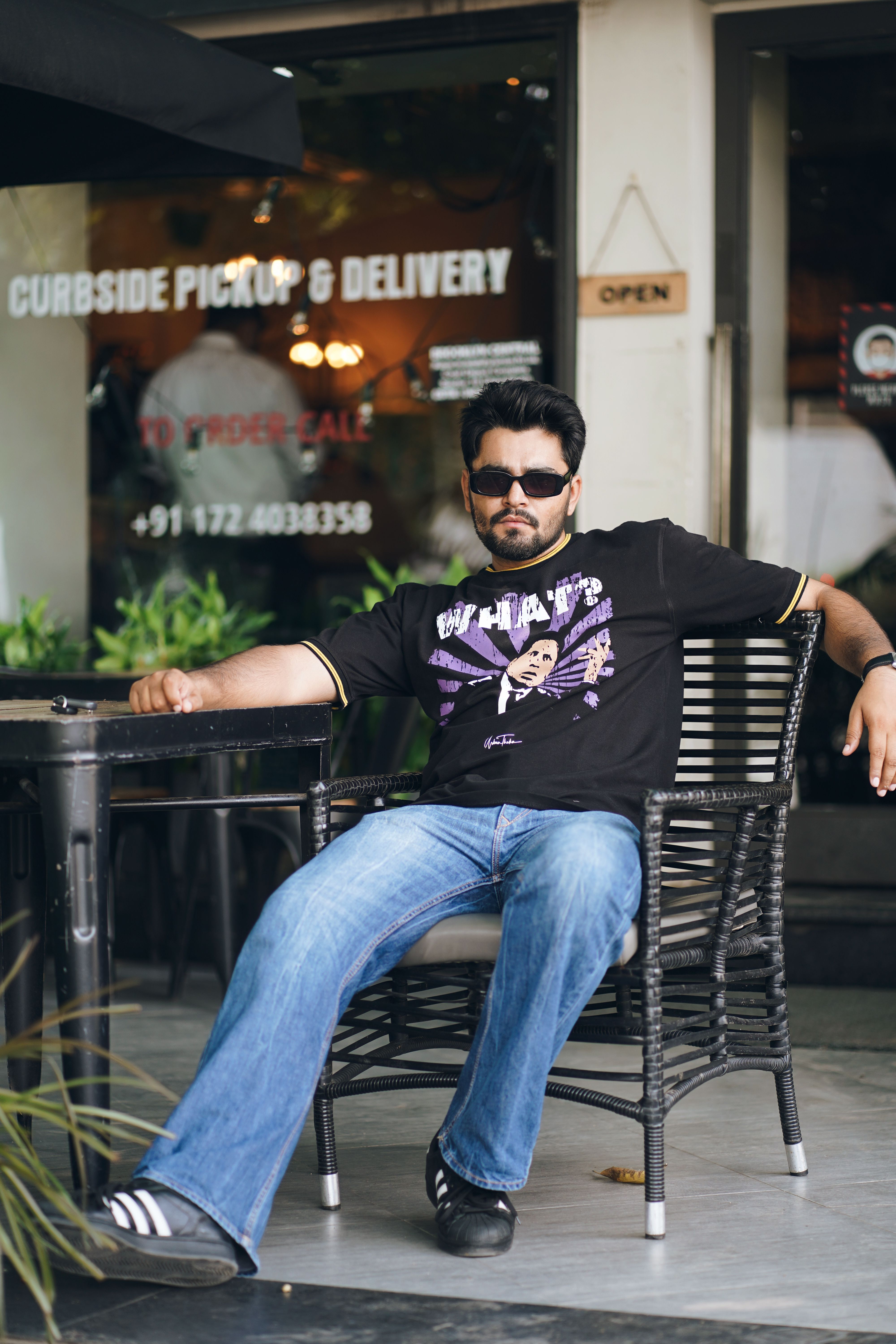 Man Lounging in Chair in front of Restaurant Entr · Free Stock Photo