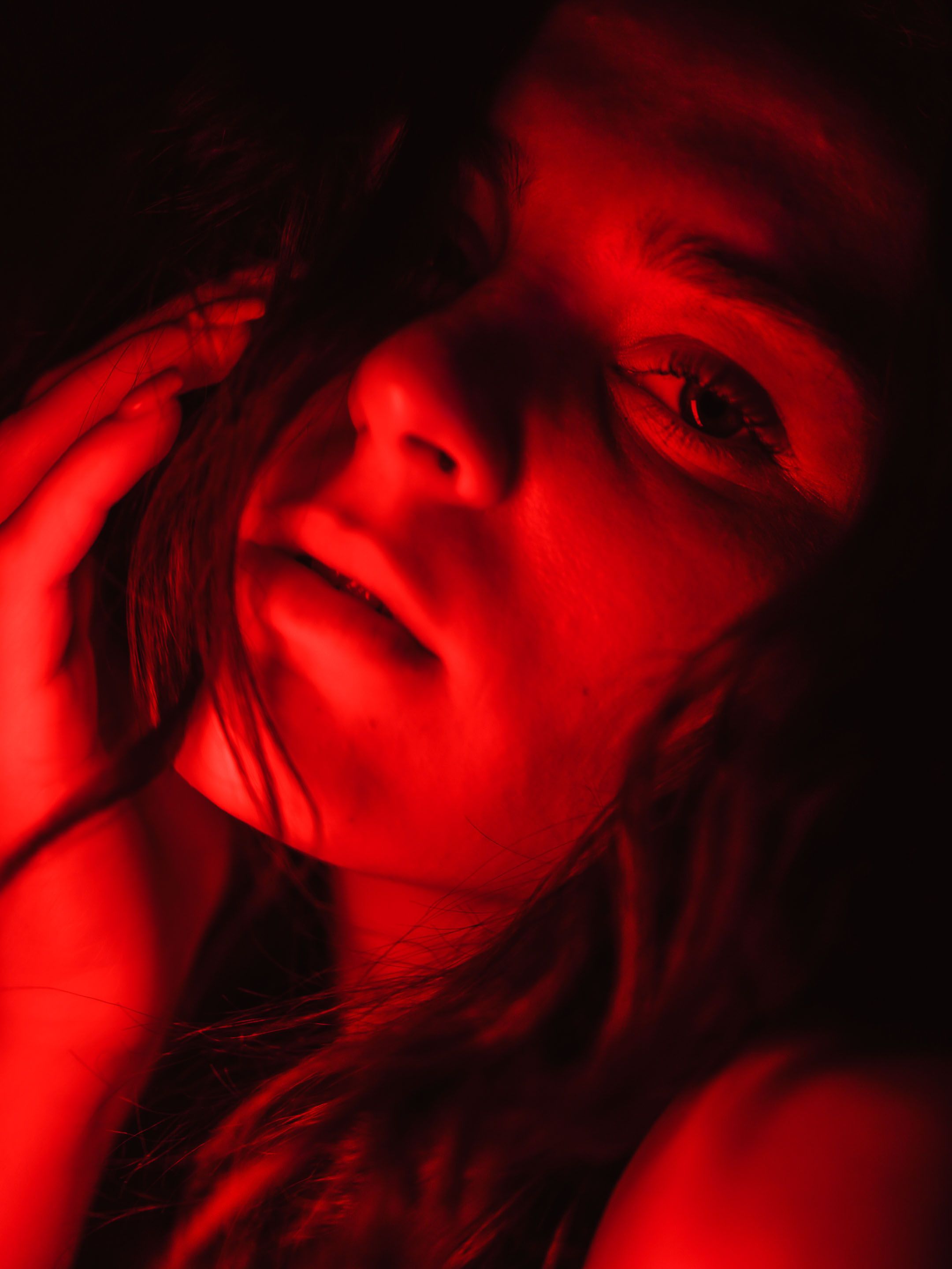 Portrait of Young Woman in Red Light · Free Stock Photo