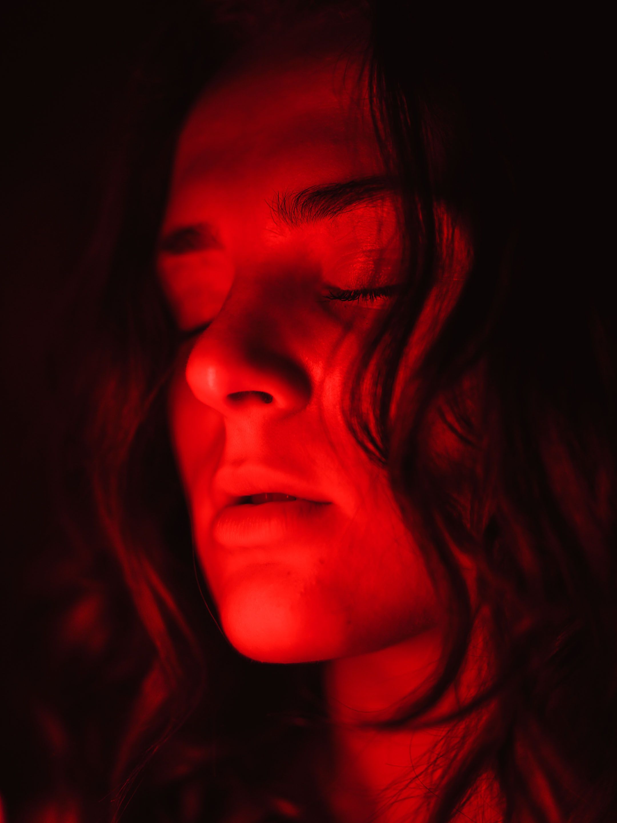 Young Woman in Dark in Red Light · Free Stock Photo