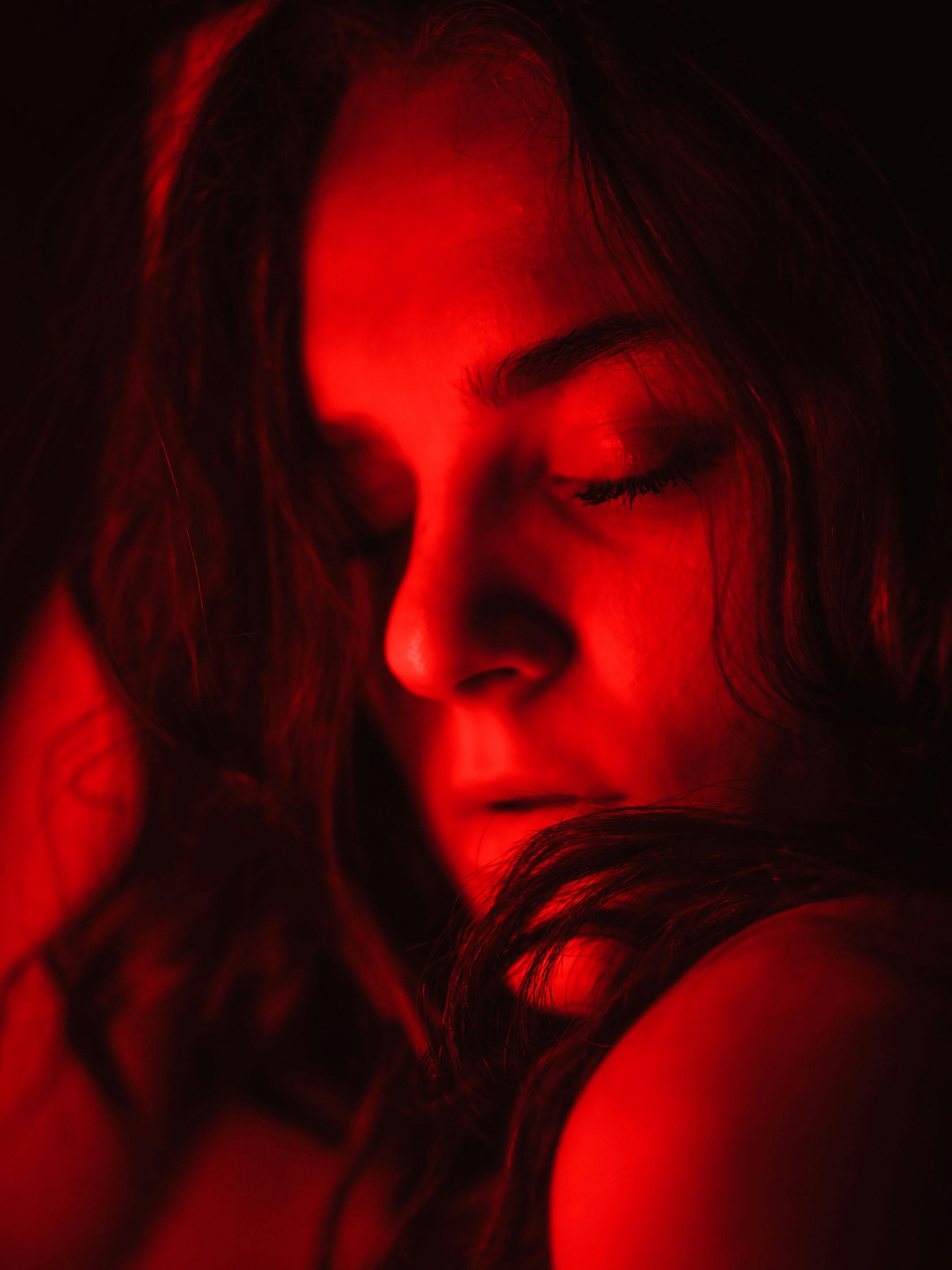 Studio Shot of a Young Woman in Red Lighting · Free Stock Photo