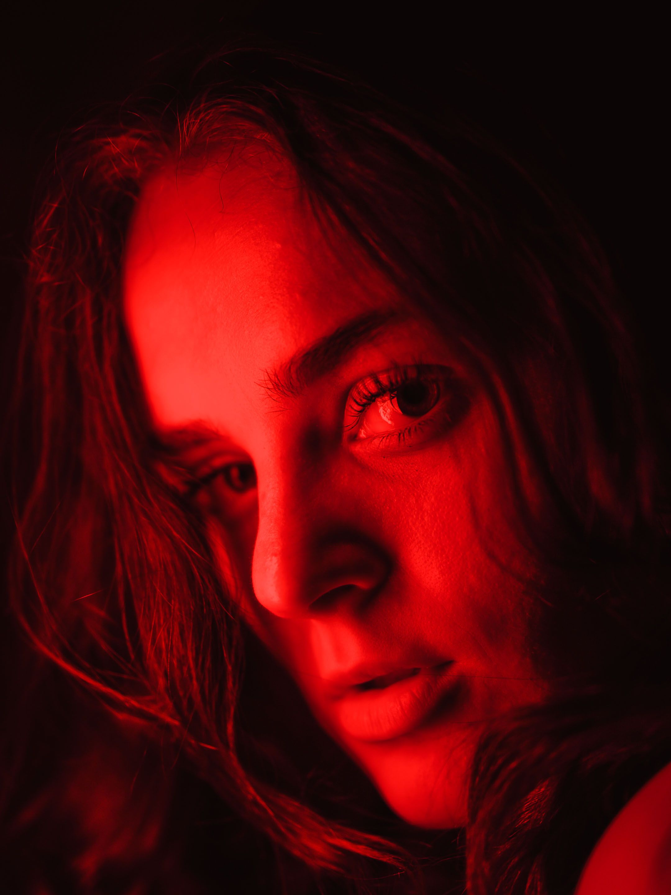 Portrait of Young Woman in Red Light · Free Stock Photo