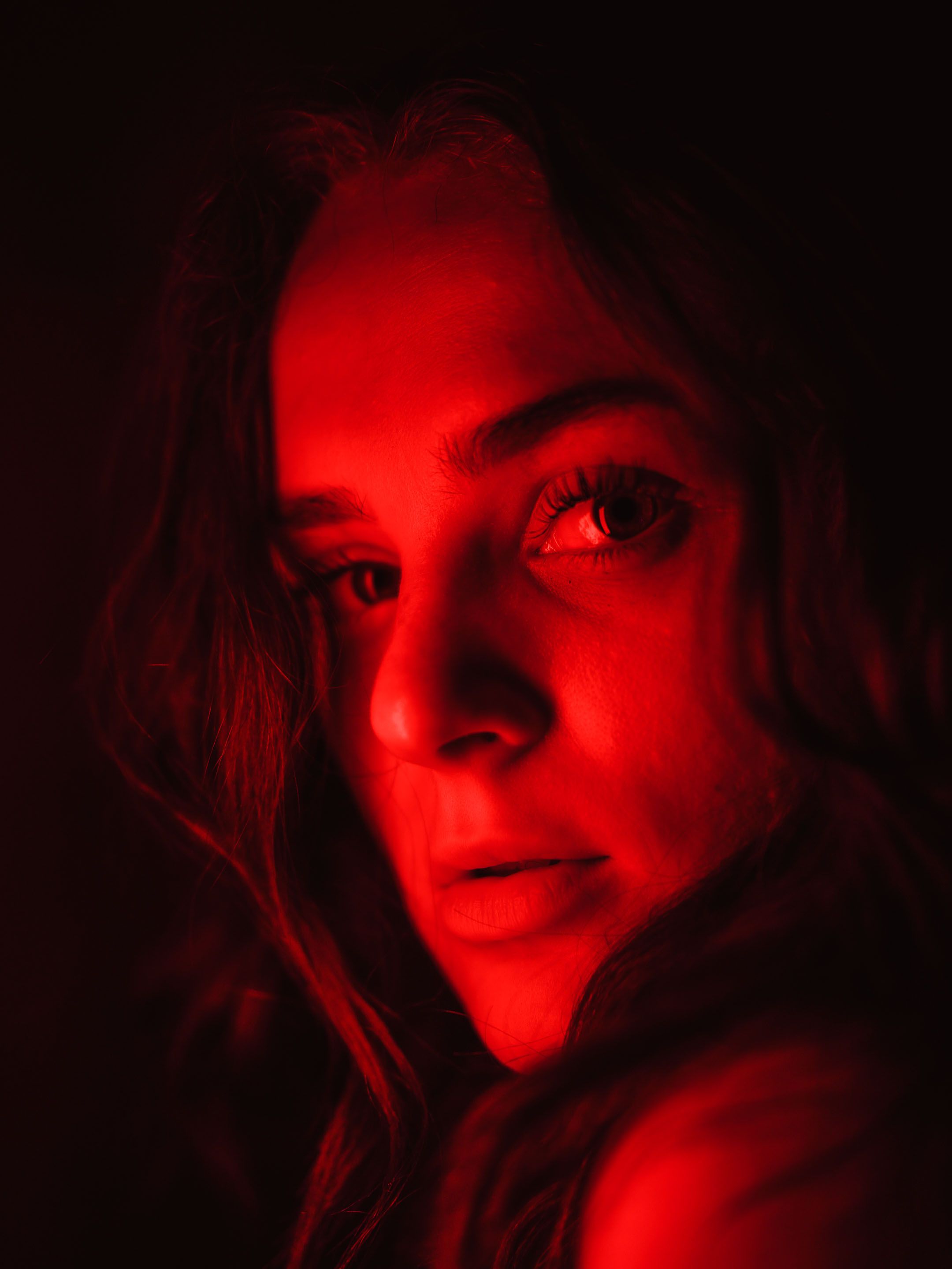 Portrait of Young Woman in Red Light · Free Stock Photo