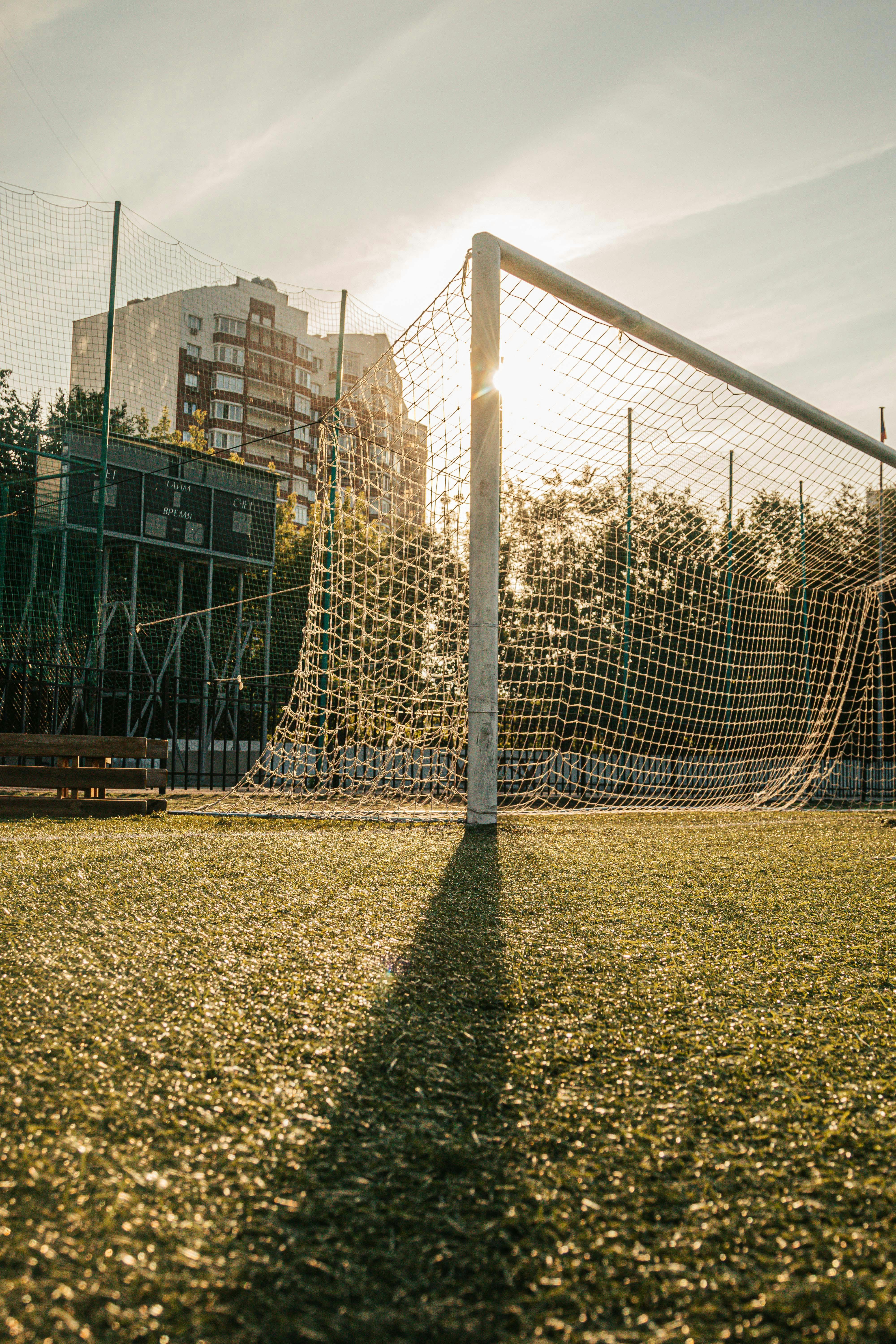 Sunset Sunlight over Goal on Football Pitch · Free Stock Photo