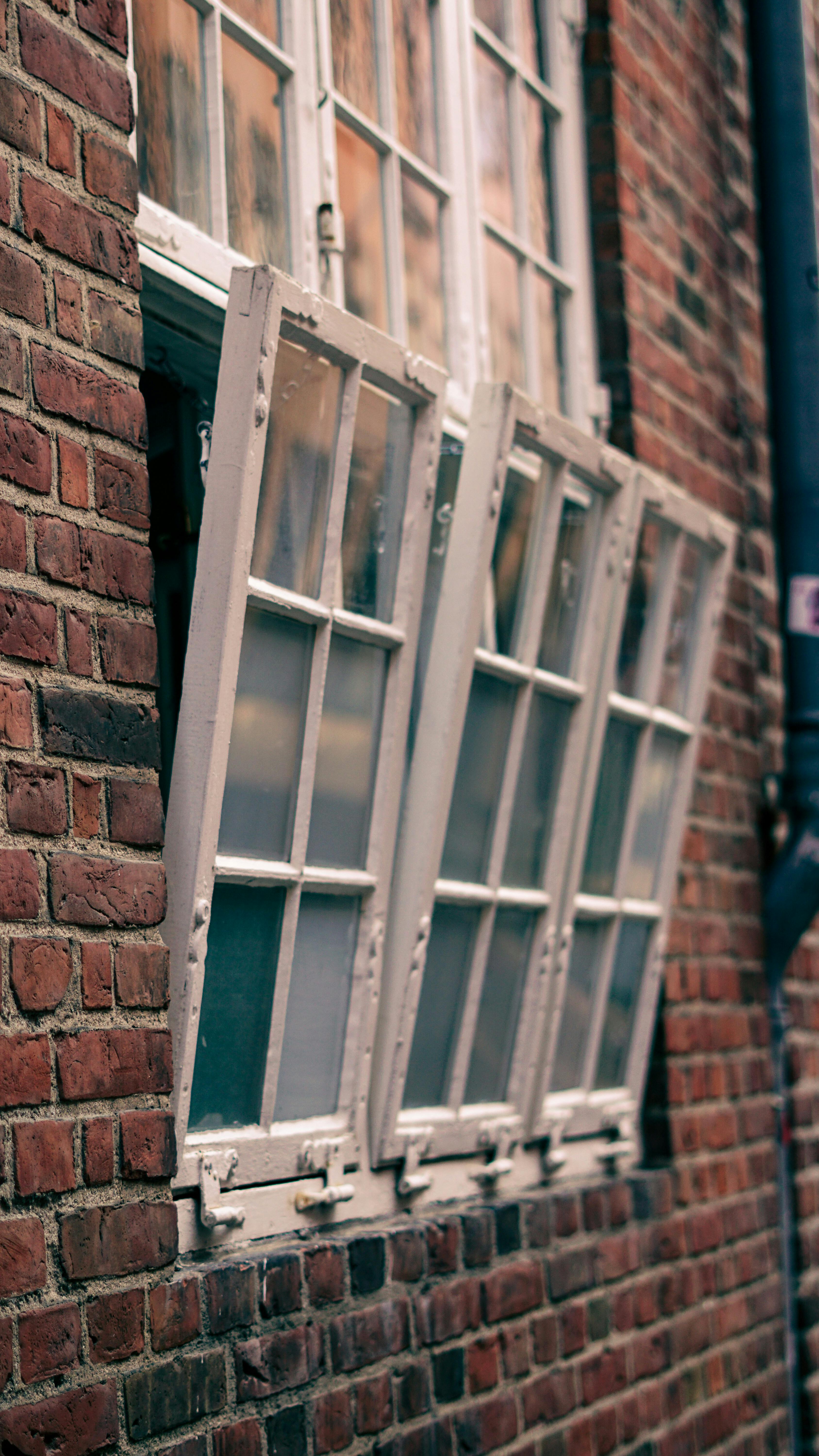 Old Hinged Windows in a Wall of Brick Building · Free Stock Photo