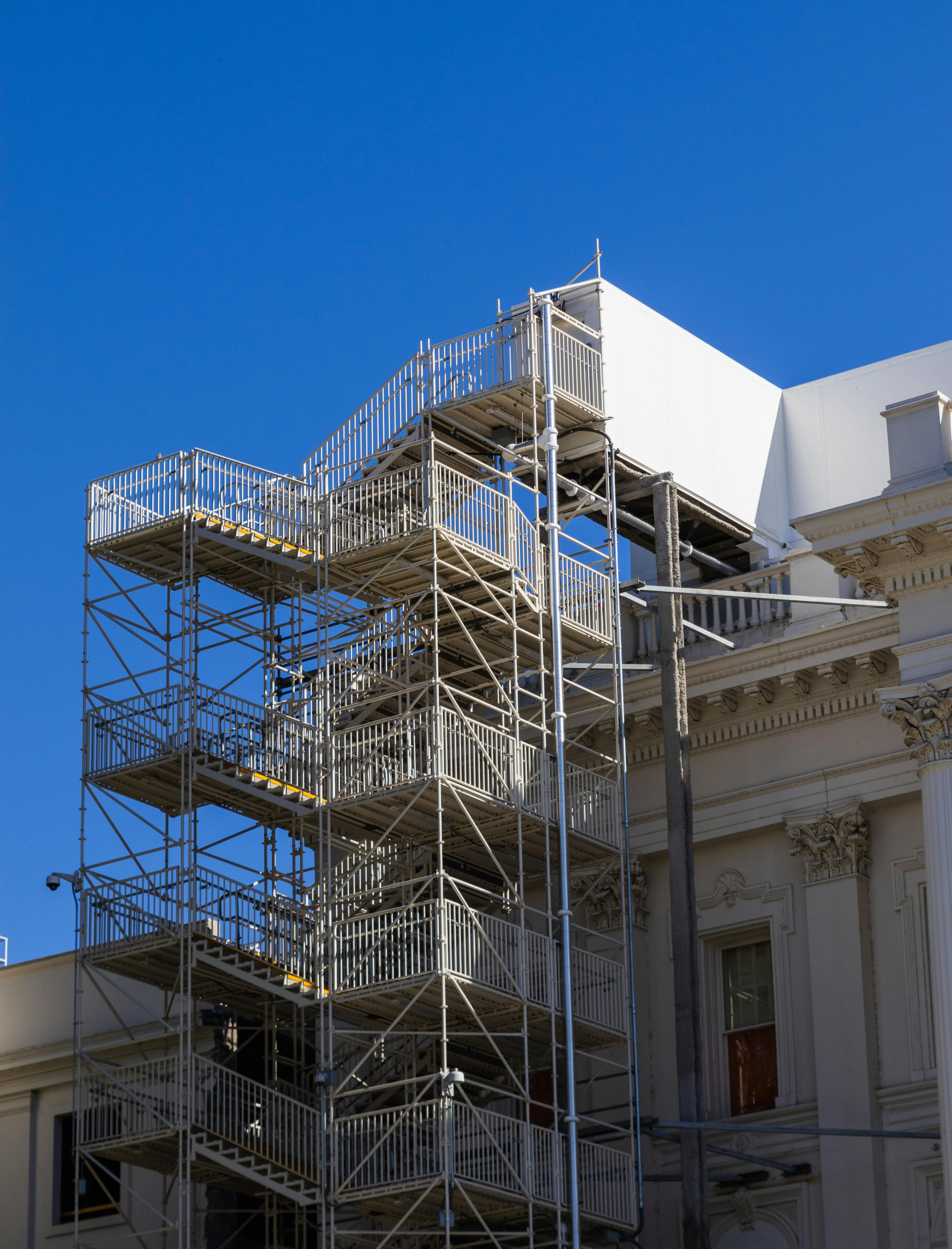 Seaside Building Surrounded by Scaffoldings · Free Stock Photo