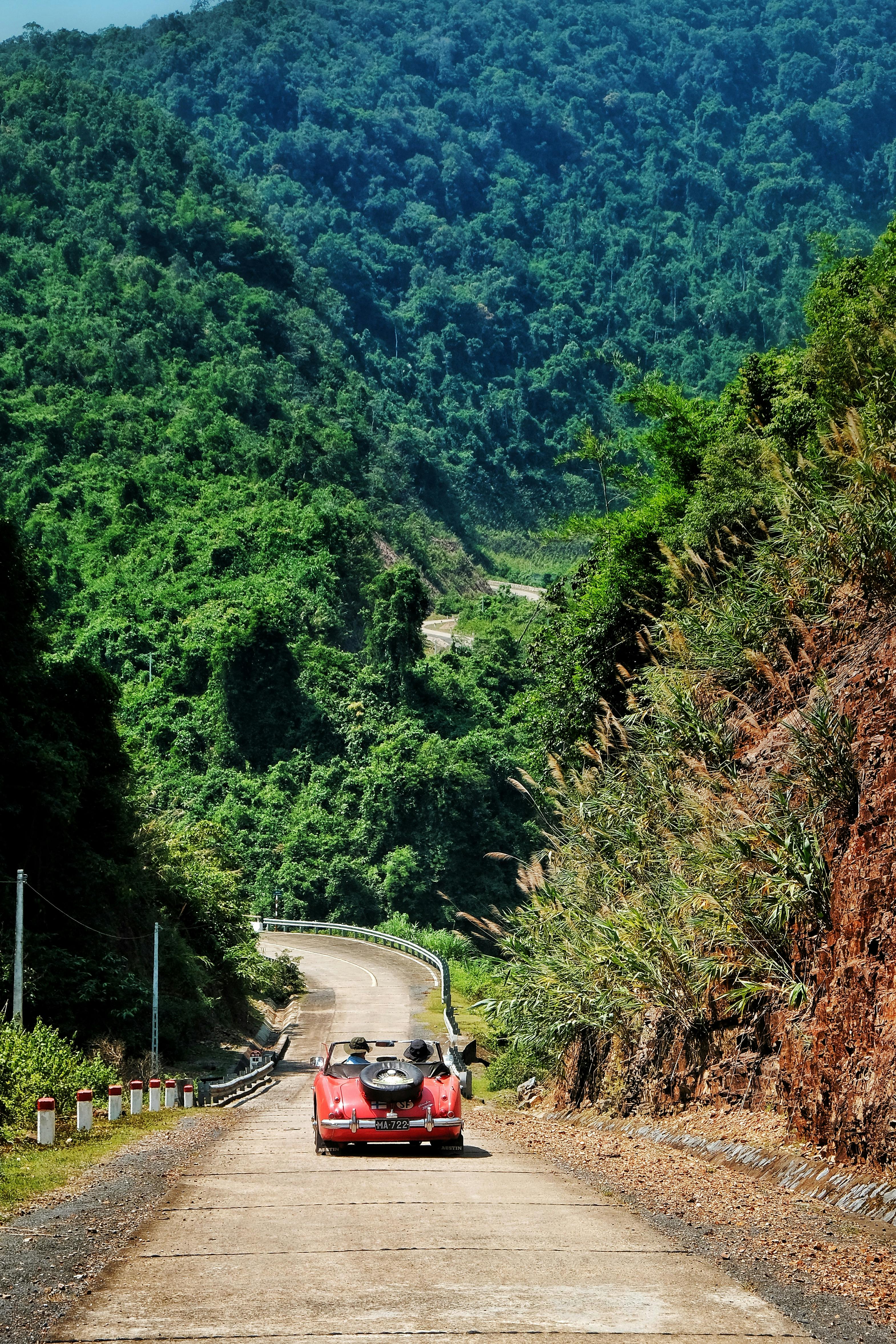 Convertible Car Driving on Road in Mountains Landscape · Free Stock Photo