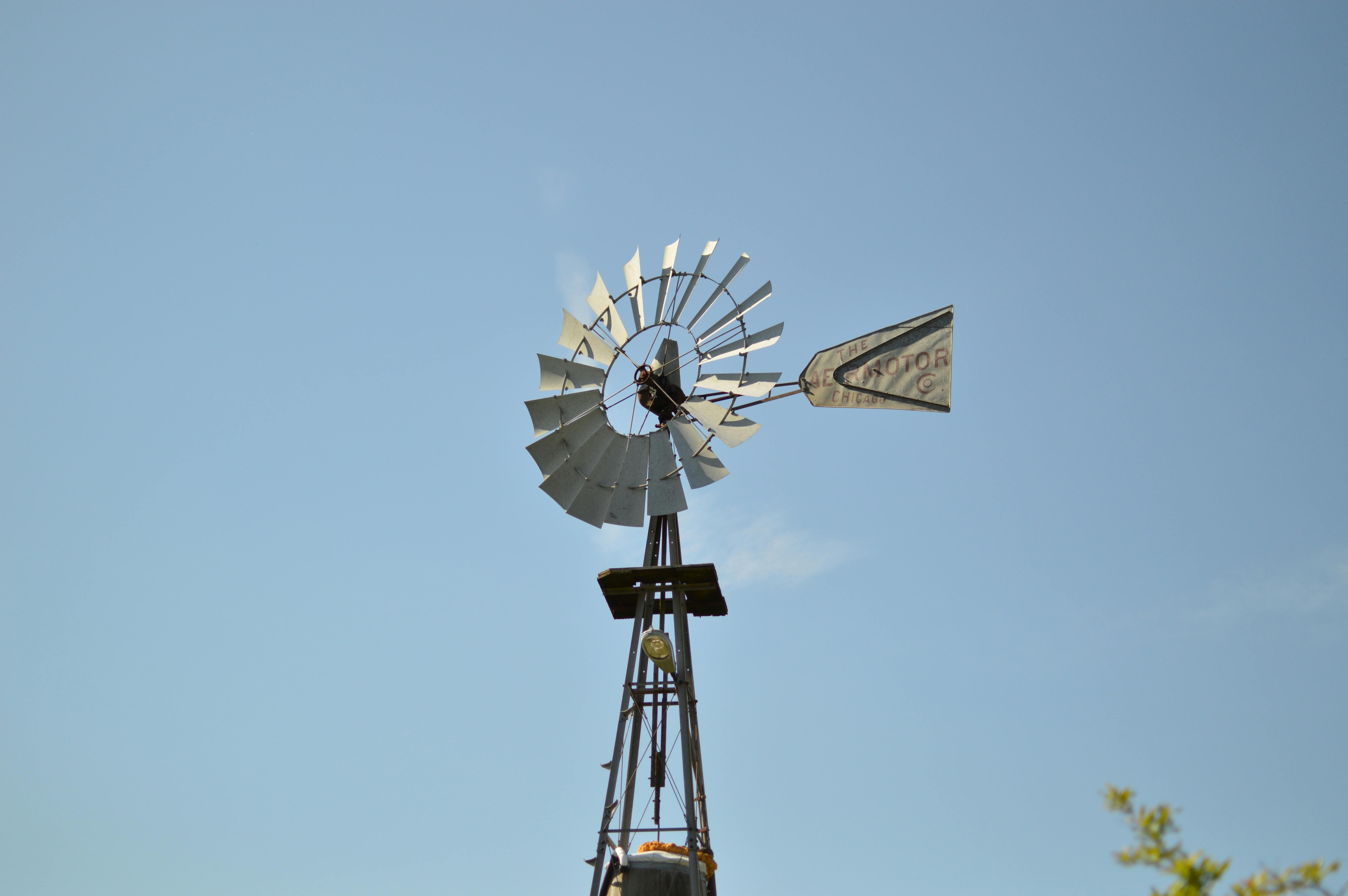 Four Windmills Near Body Of Water · Free Stock Photo