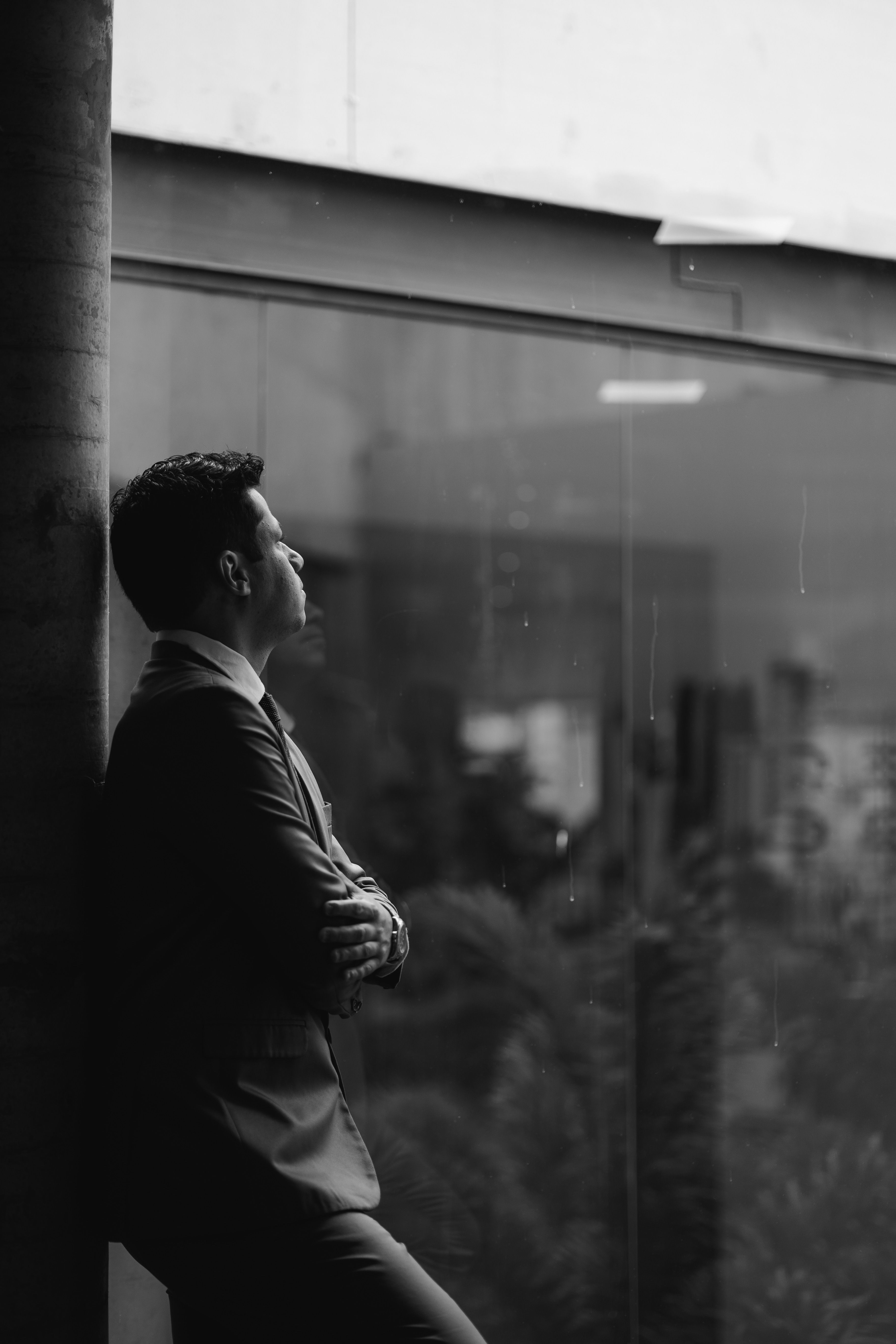 Elegant Man in a Suit Standing with His Back against the Wall · Free ...