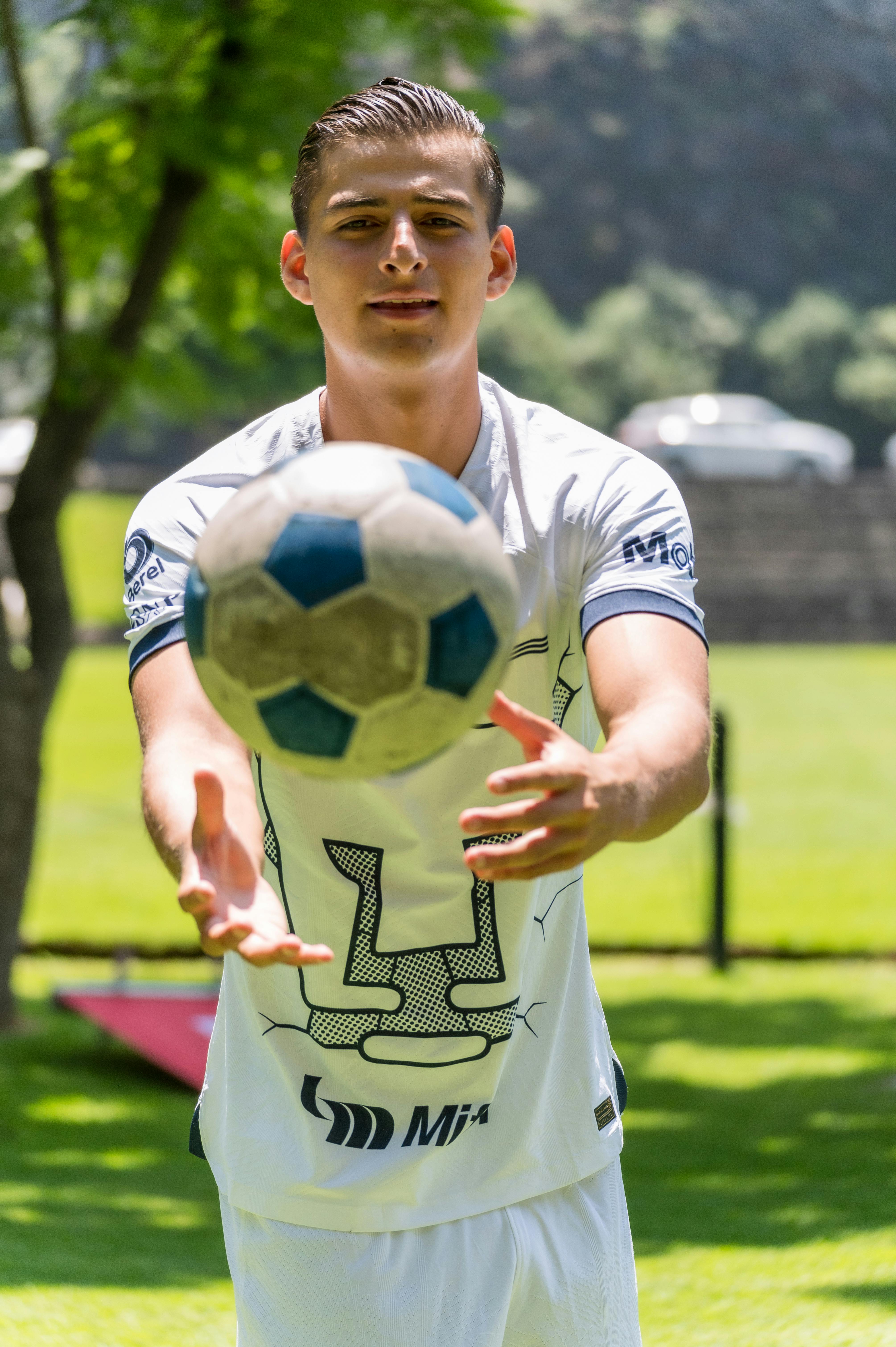 Football Player Catching a Ball · Free Stock Photo