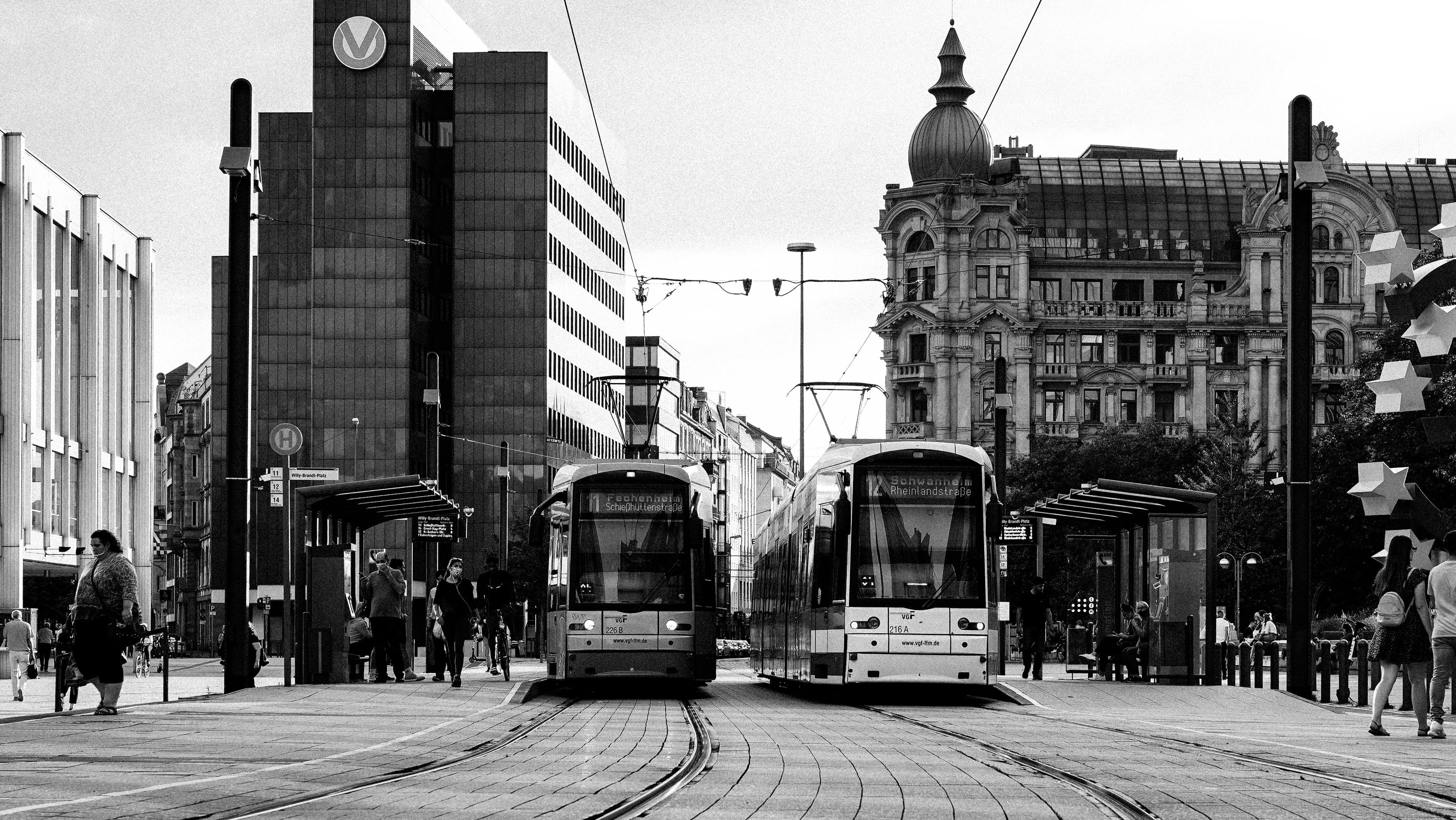 Trams in a City in a Grayscale Photo · Free Stock Photo