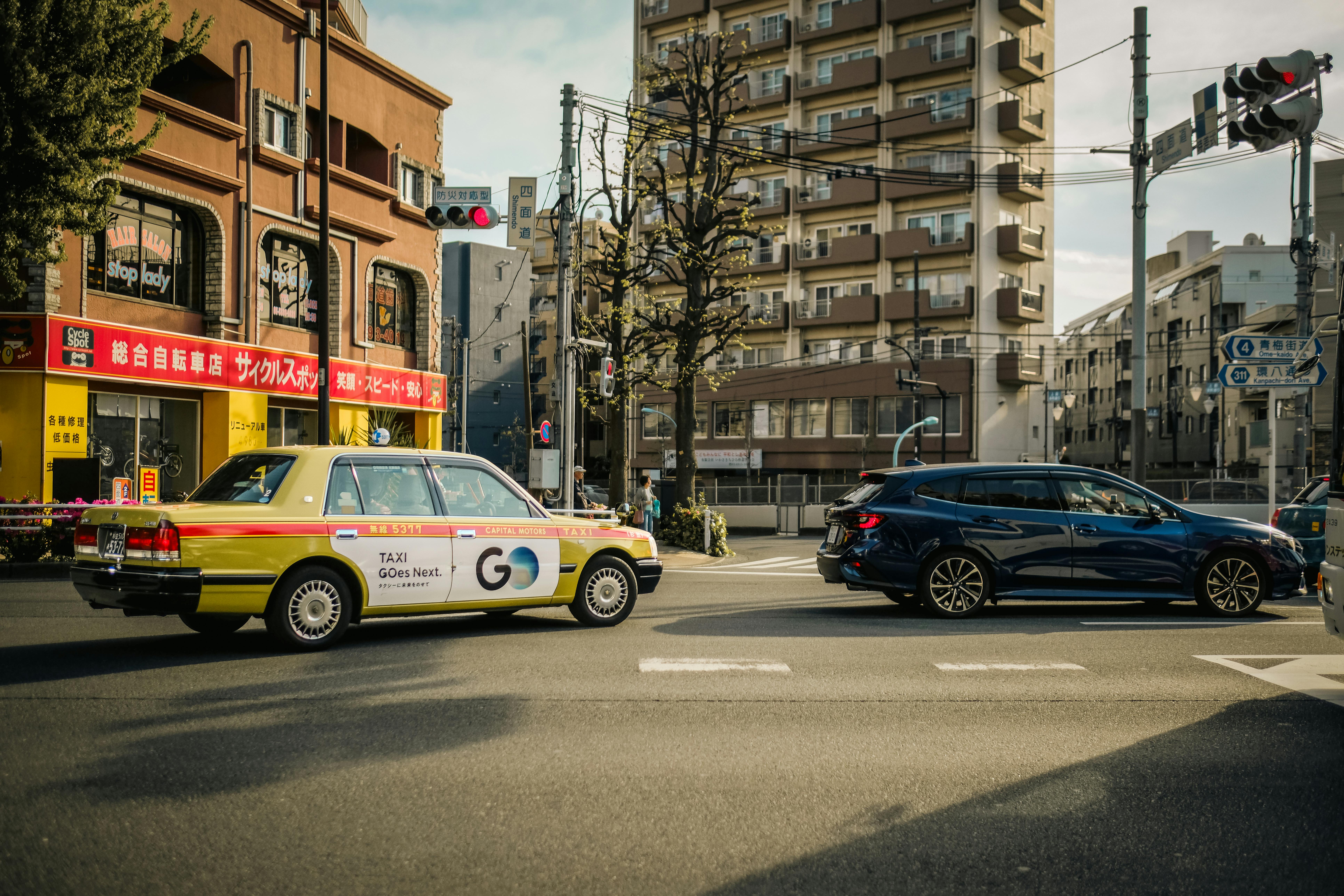 Cars Driving on City Road in Downtown · Free Stock Photo