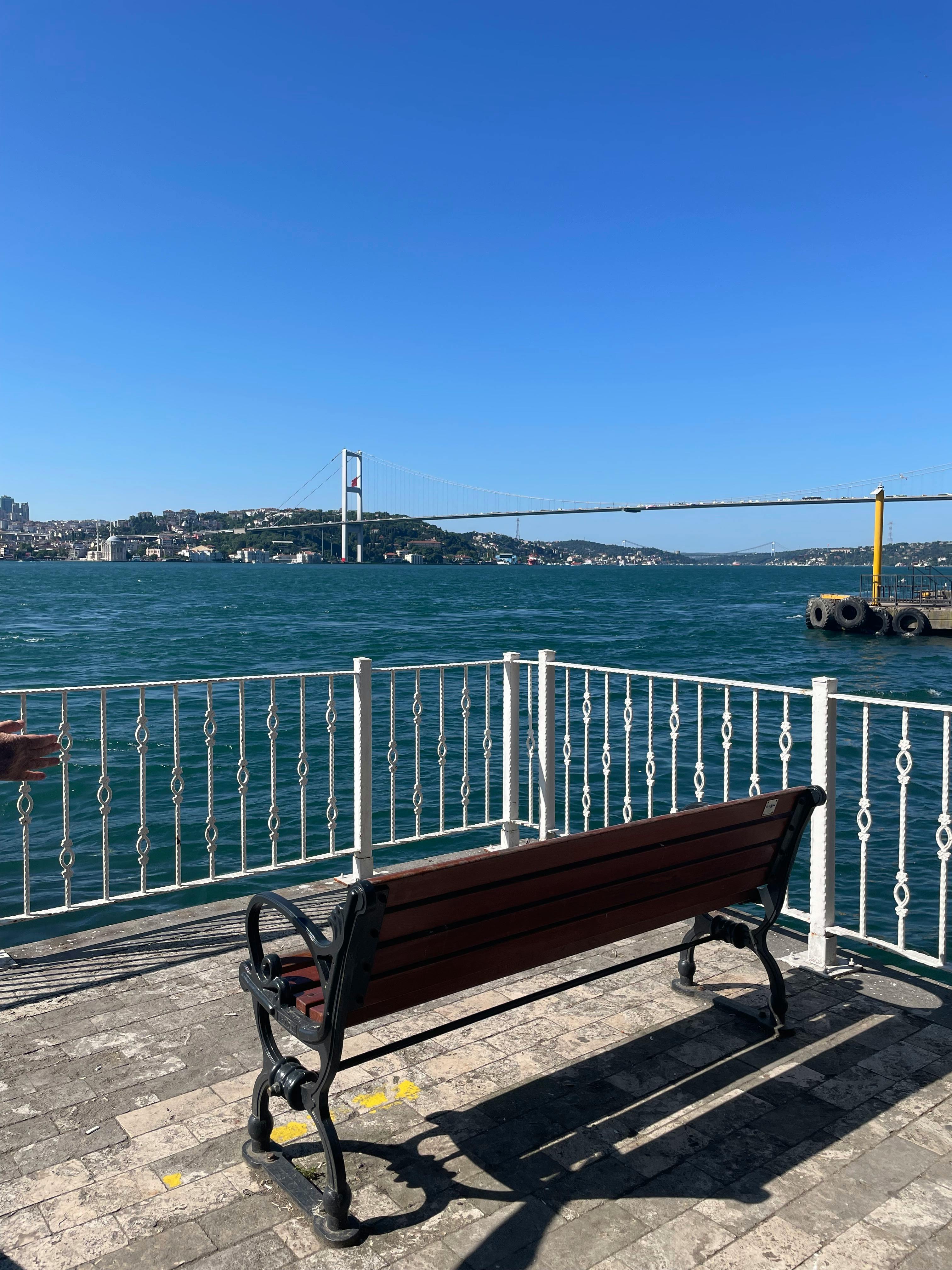 Sunlit Bench on Sea Shore in Istanbul · Free Stock Photo