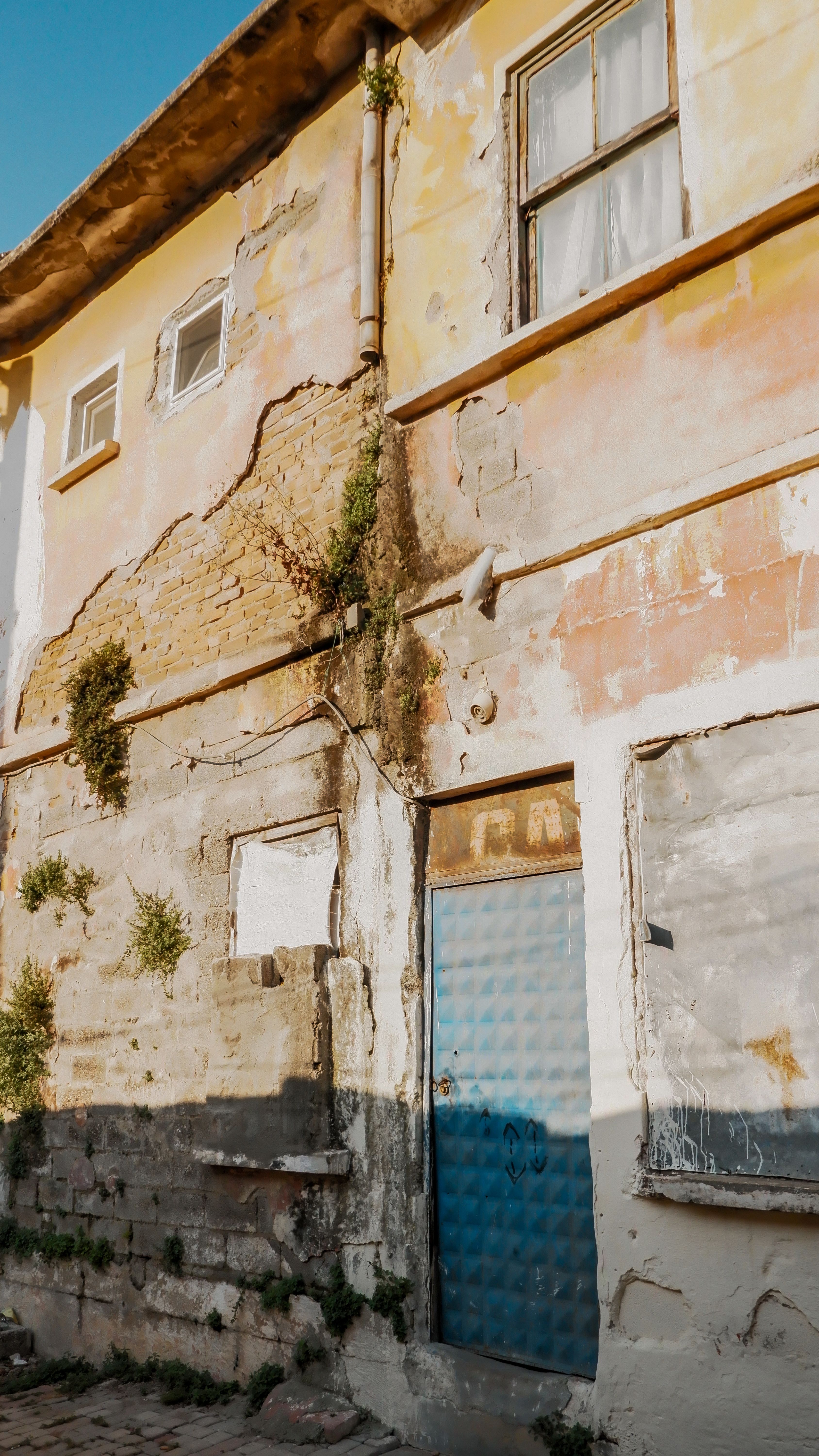 Sunlit, Damaged Building Wall · Free Stock Photo