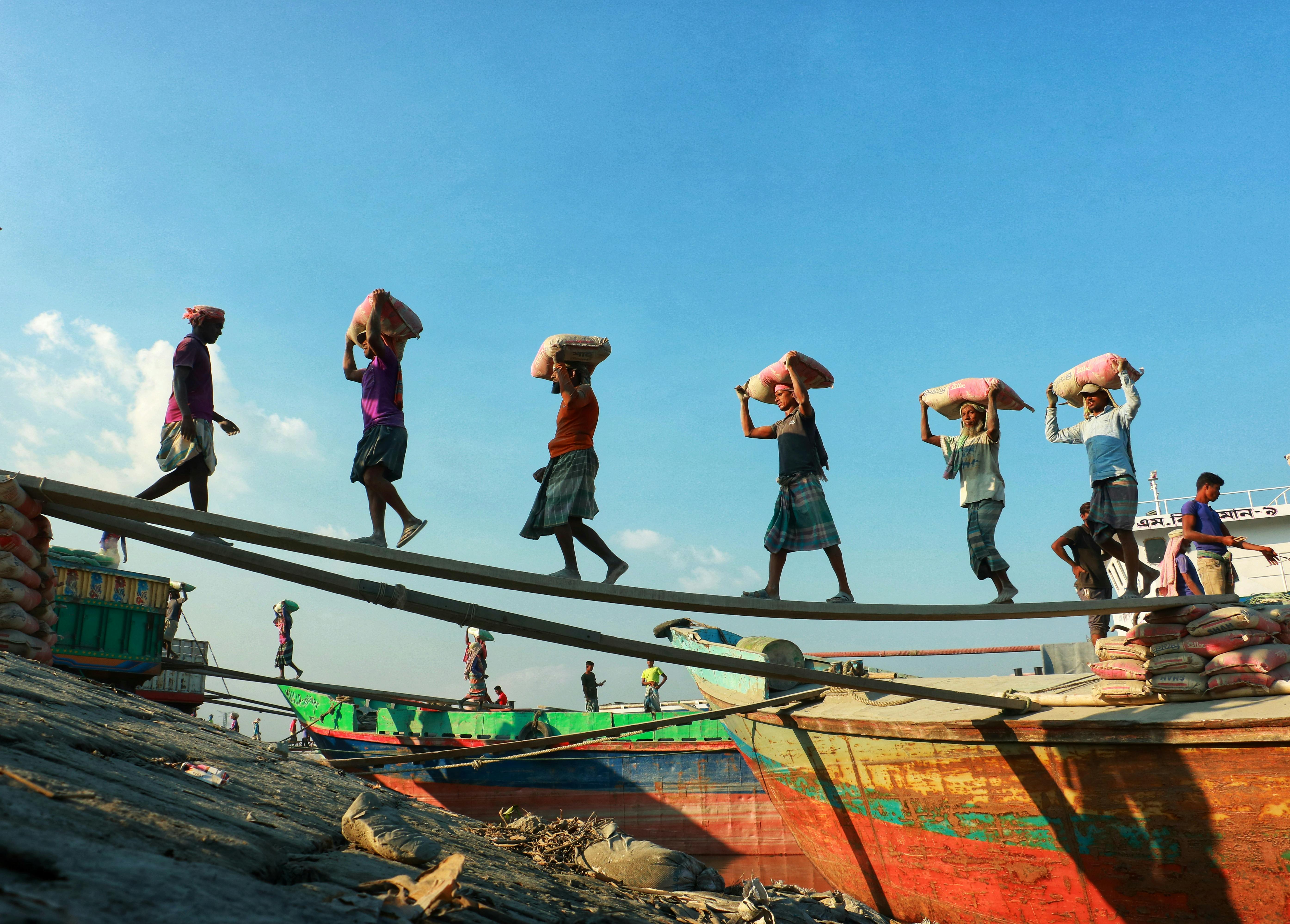 Man Carrying Bucket of Mud · Free Stock Photo