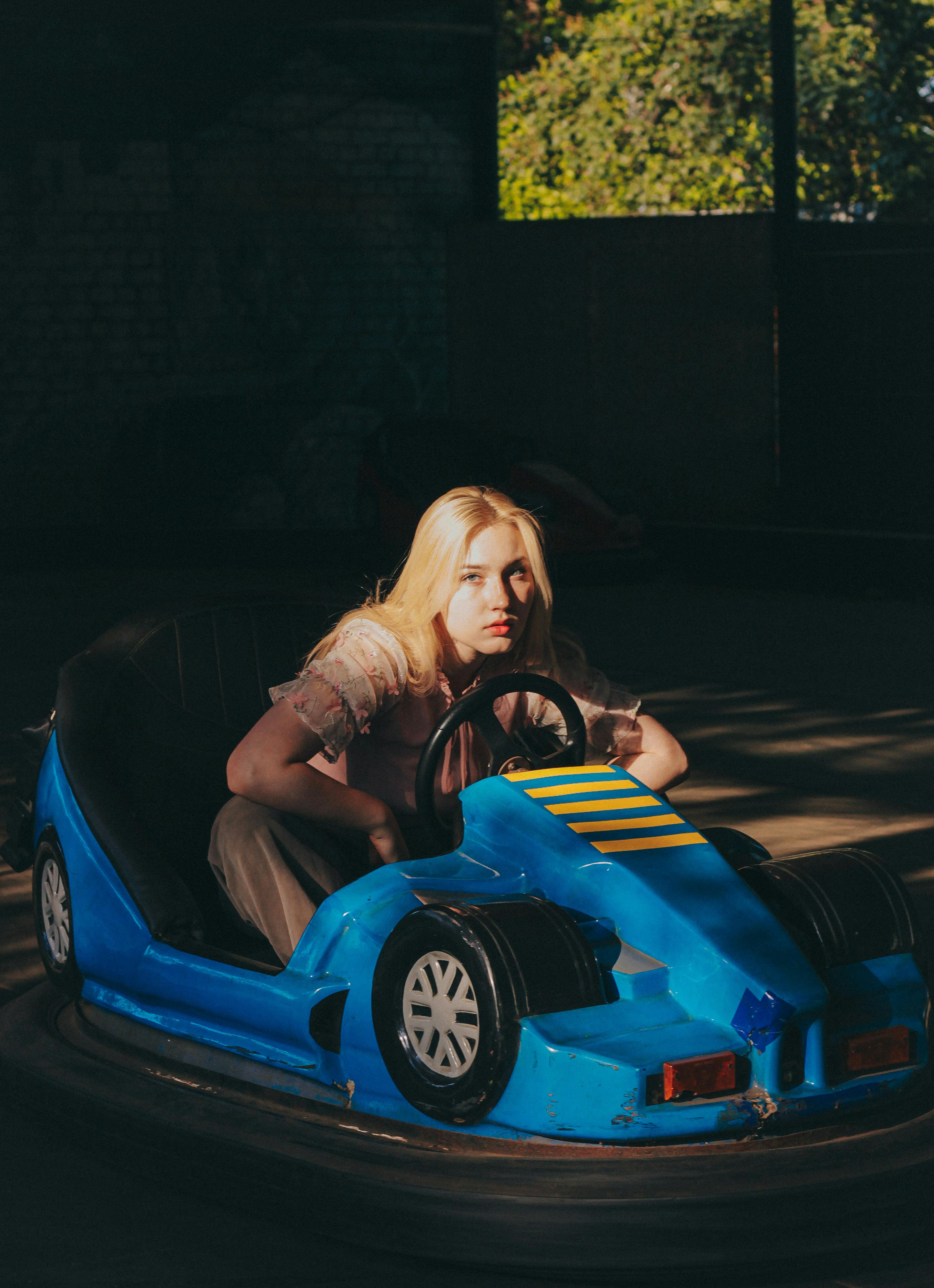 Young Woman Sitting in a Bumper Car · Free Stock Photo