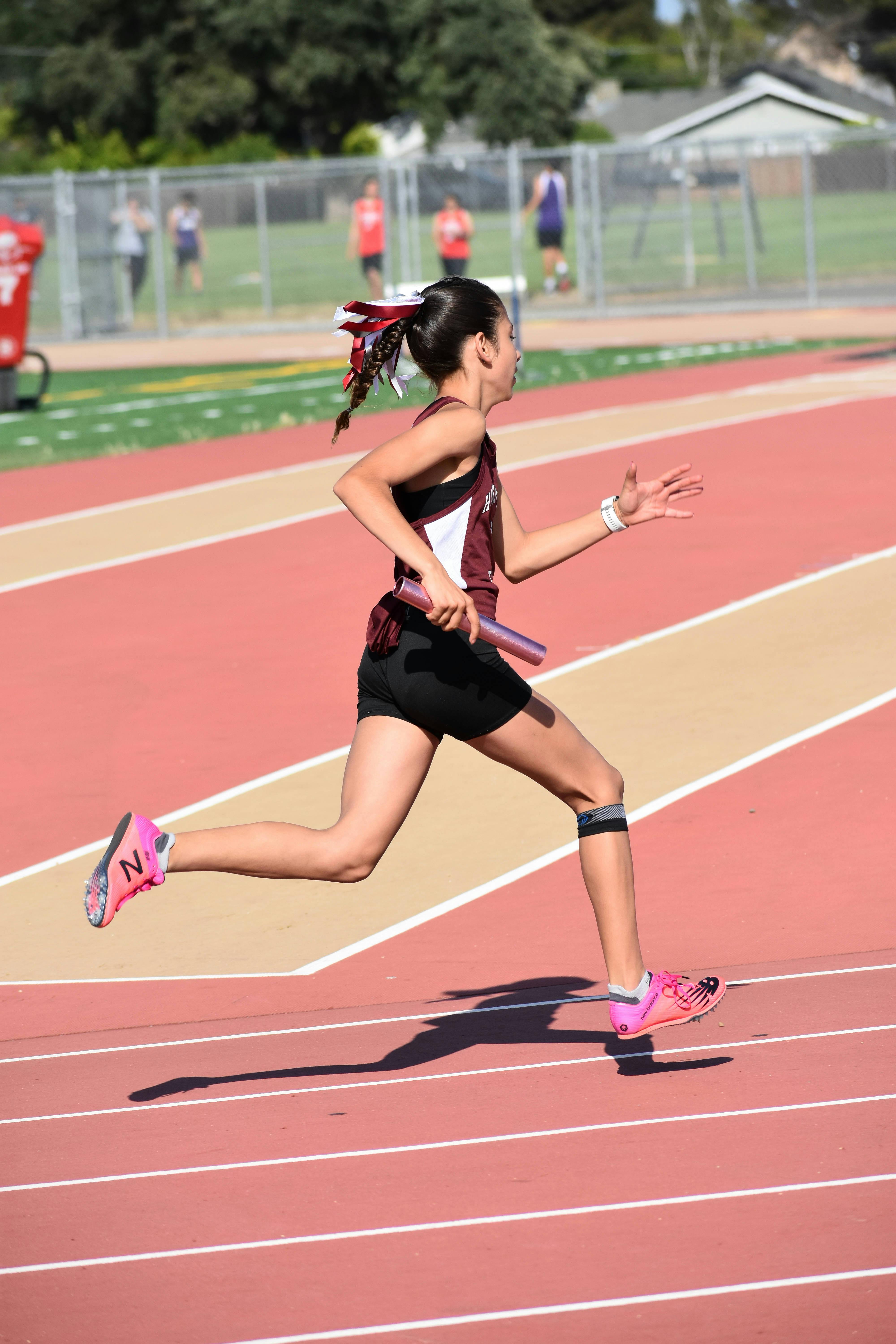 Woman Running with Baton · Free Stock Photo
