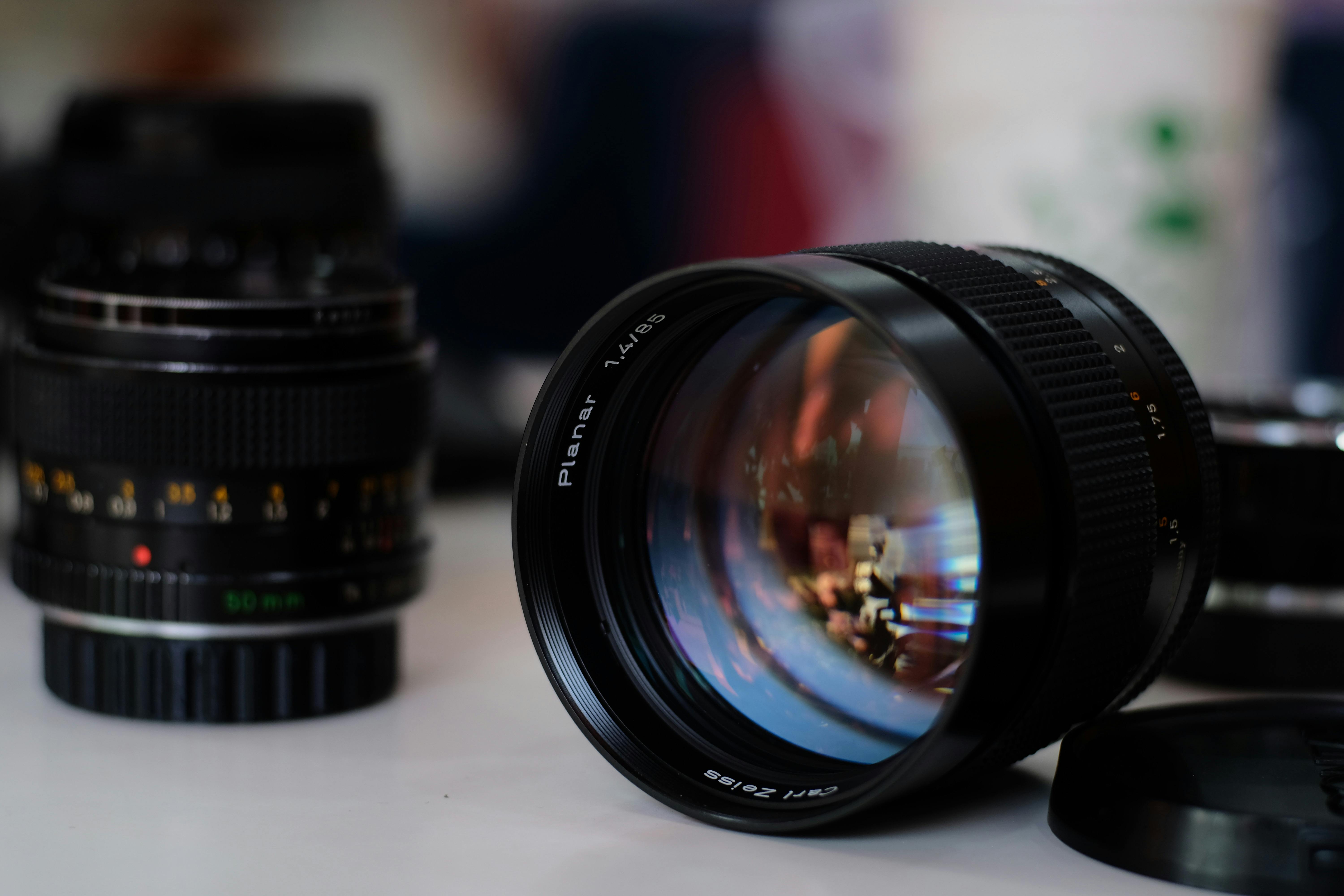 Black Canon Zoom Lens Leaning on Book · Free Stock Photo
