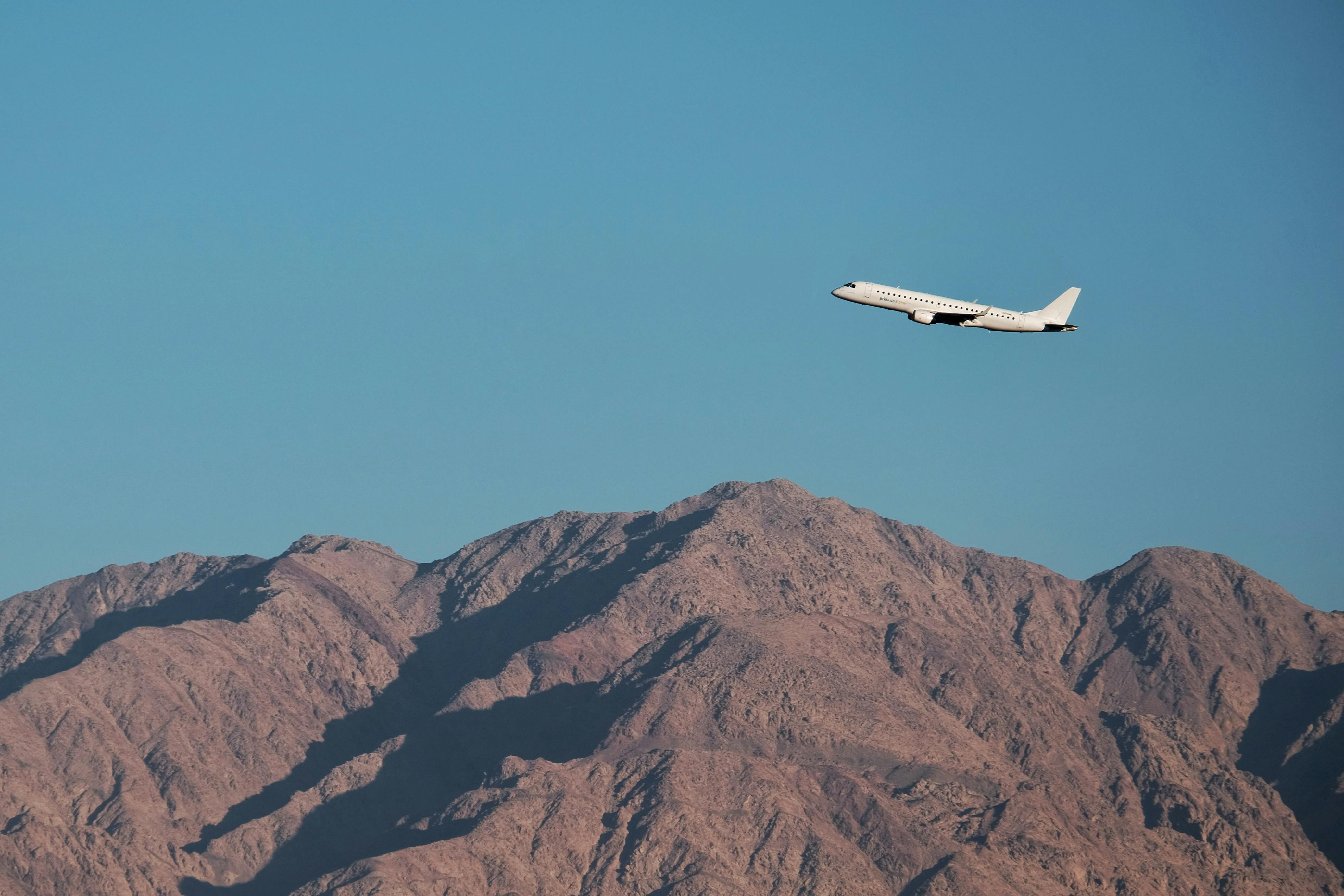 Airplane Flying over Rocky Mountains · Free Stock Photo