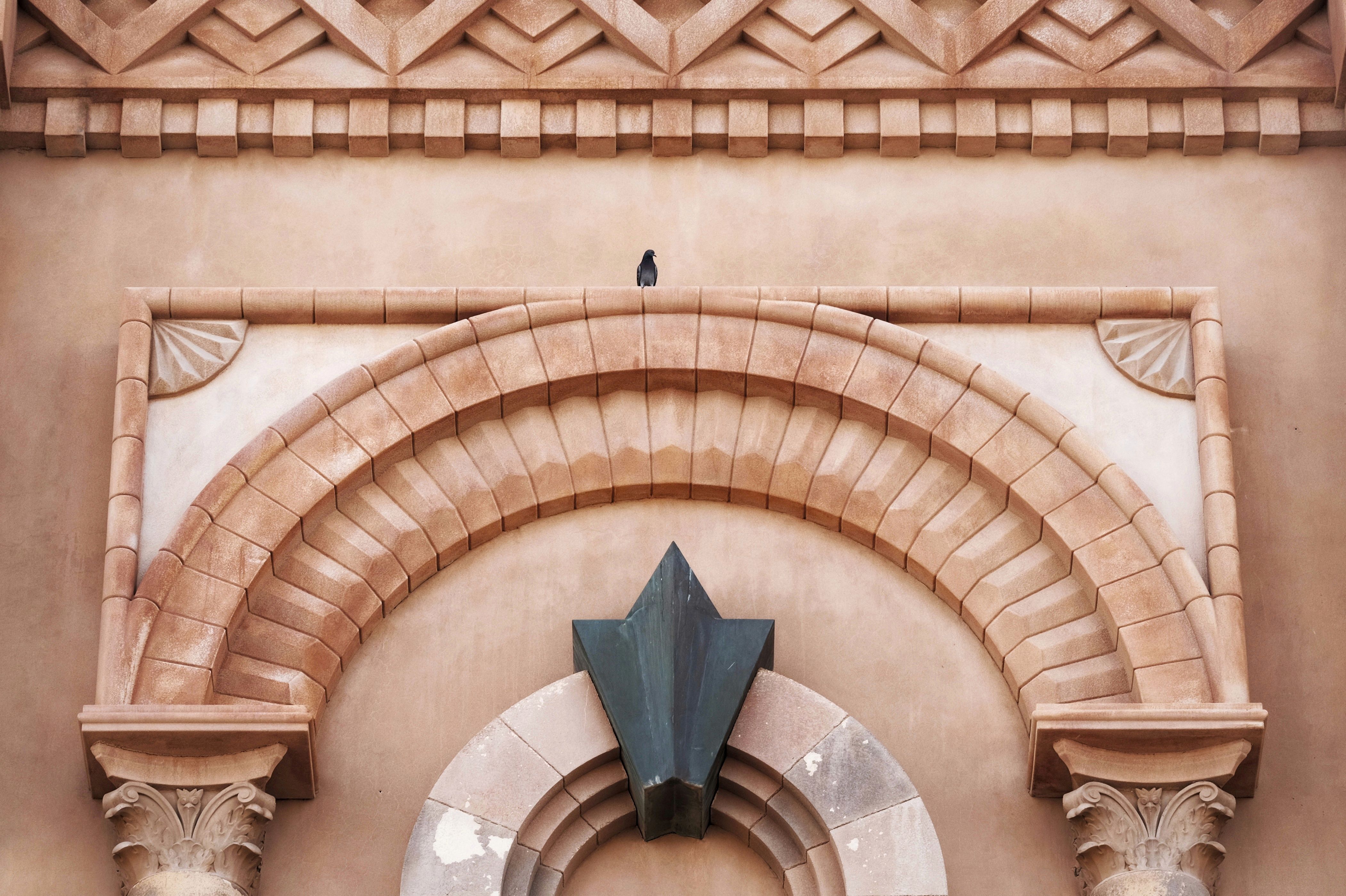An Arch above the Entrance in an Antique Building · Free Stock Photo