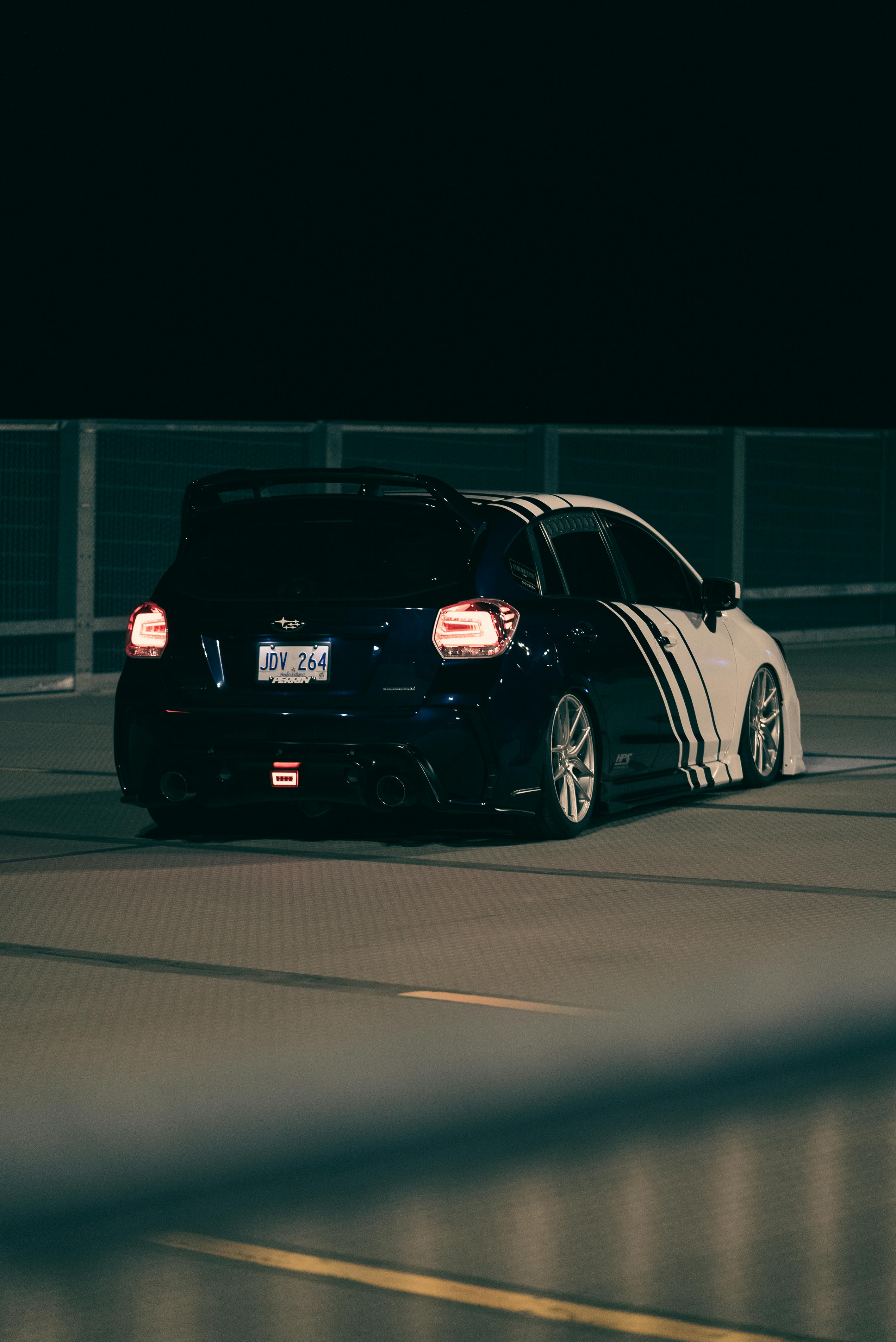 A Modified Subaru WRX on a Parking Lot at Night · Free Stock Photo