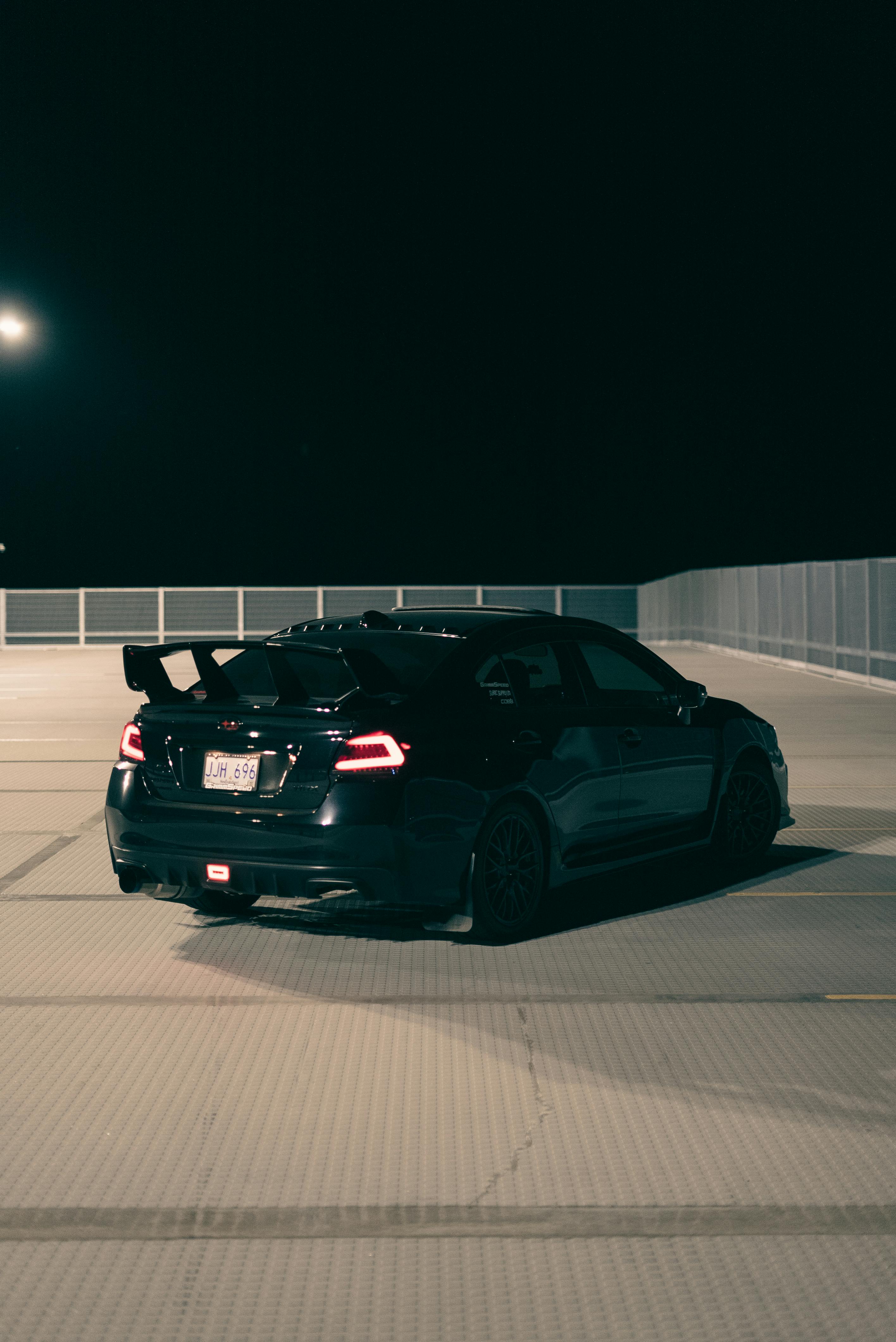 A Modified Subaru WRX on a Parking Lot at Night · Free Stock Photo