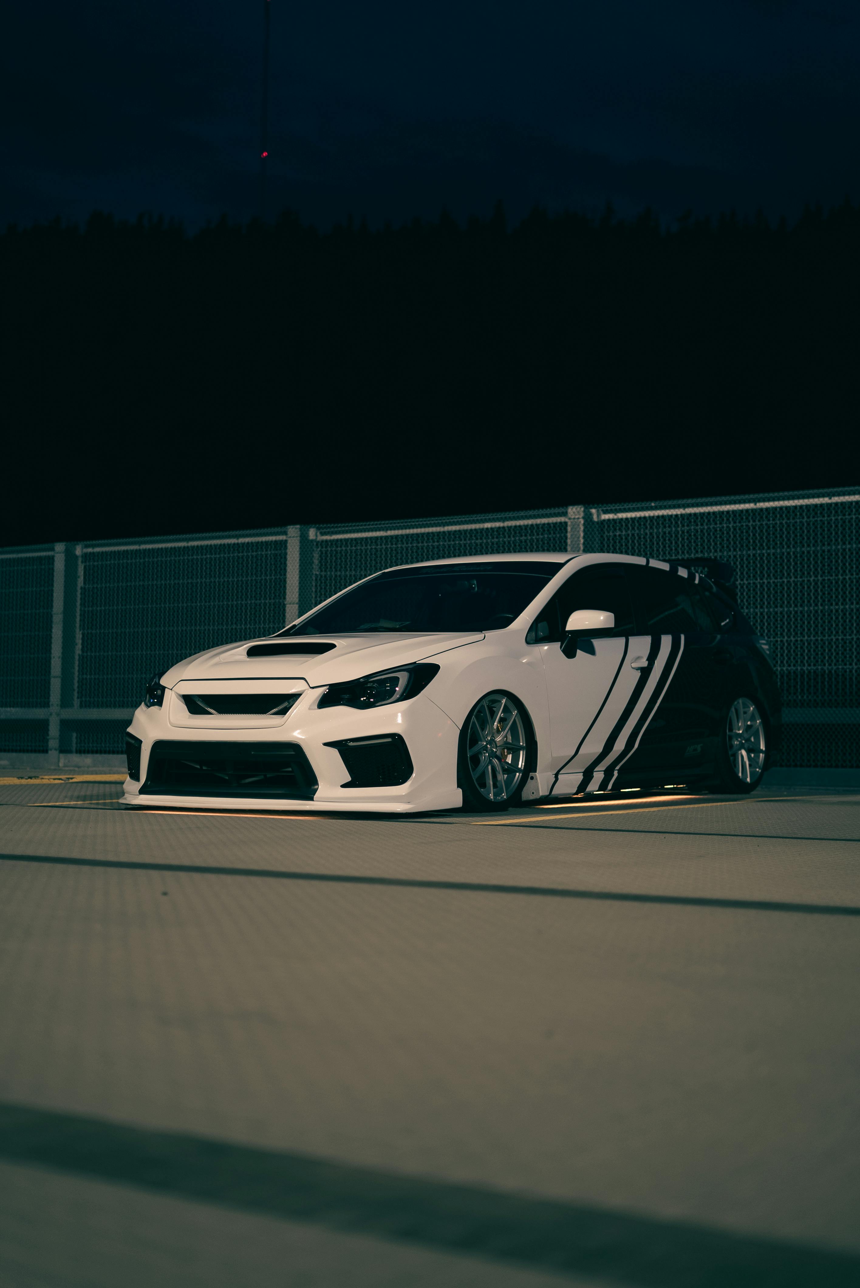 A Modified Subaru WRX on a Parking Lot at Night · Free Stock Photo