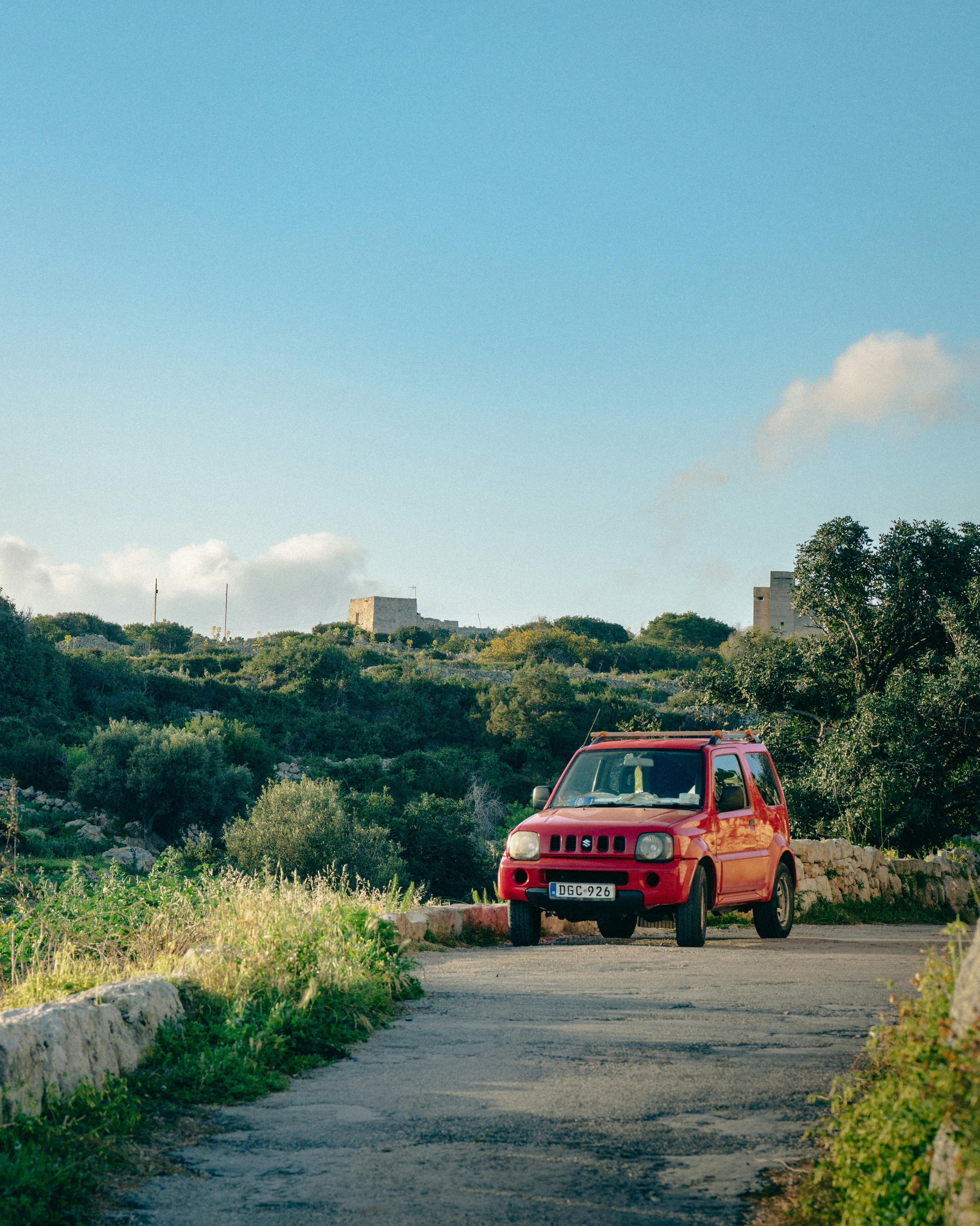 Red Suzuki Jimny on Road in Countryside · Free Stock Photo
