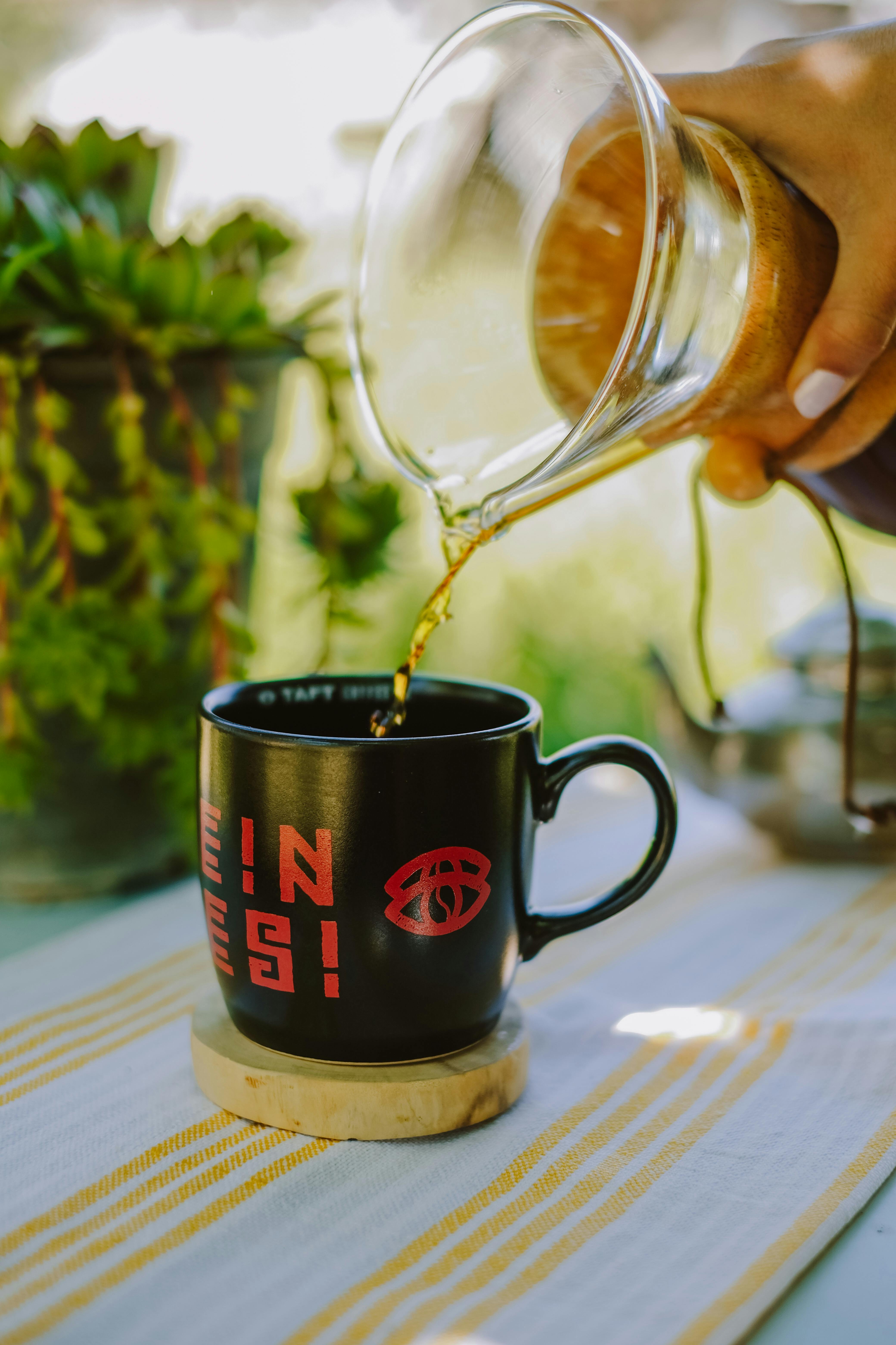 Person Pouring Coffee to a Cup · Free Stock Photo