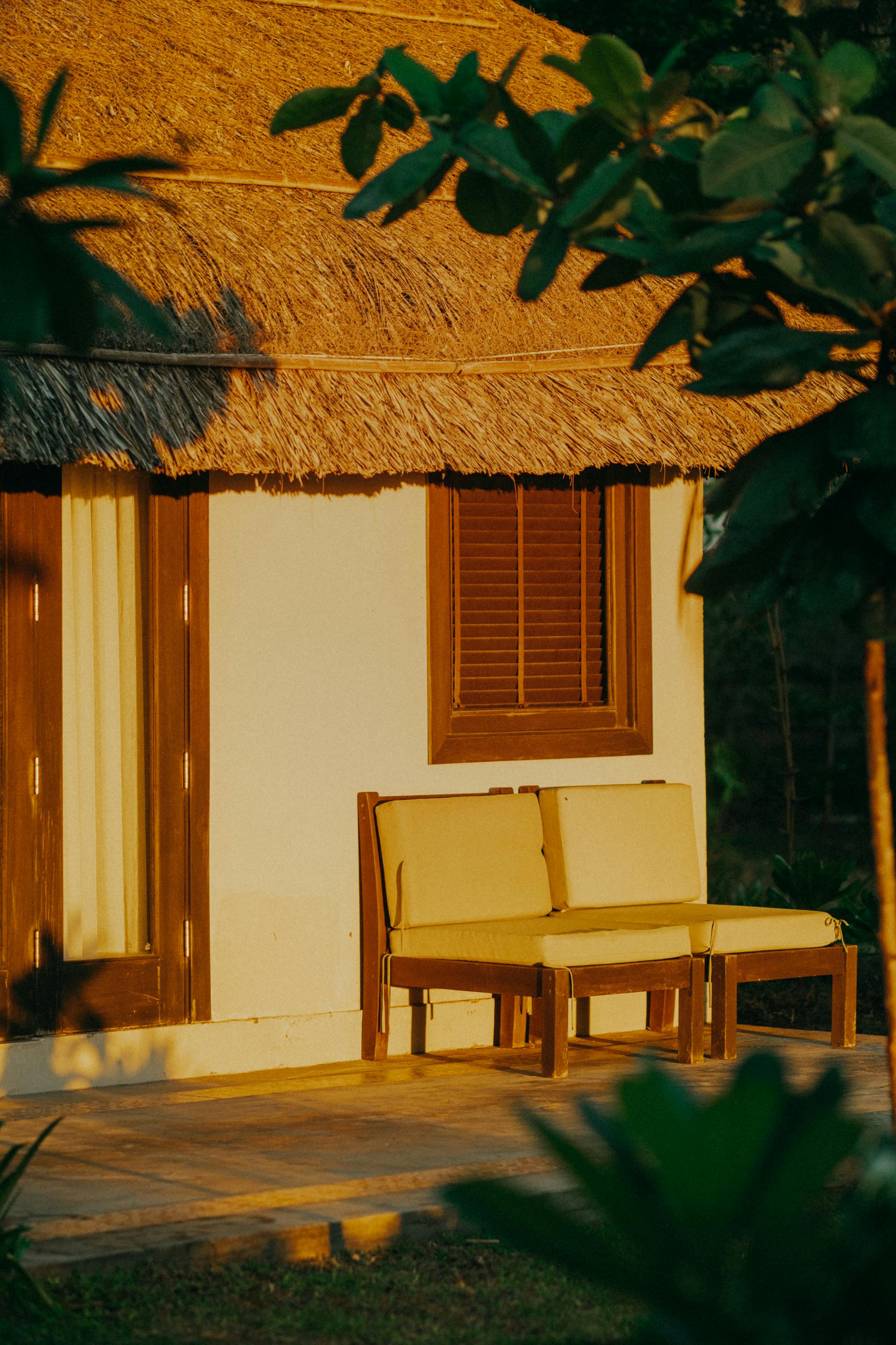 Chairs outside a Thatched Hut at Sunset · Free Stock Photo