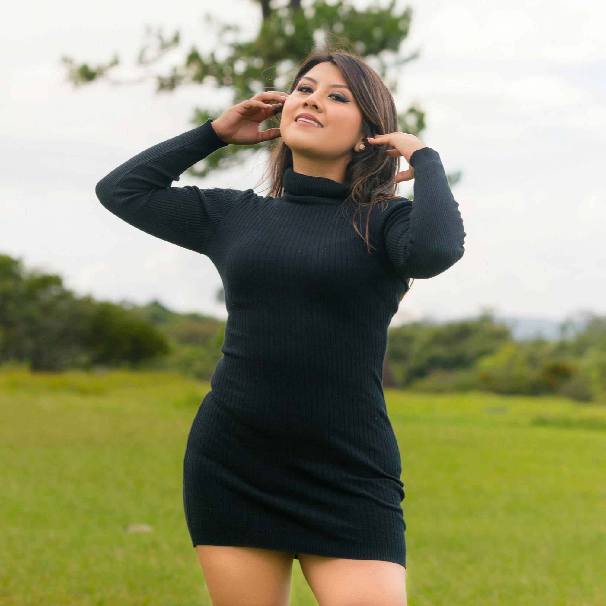 Woman in Bodycone Dress and Pearls Looking in Mirror · Free Stock Photo