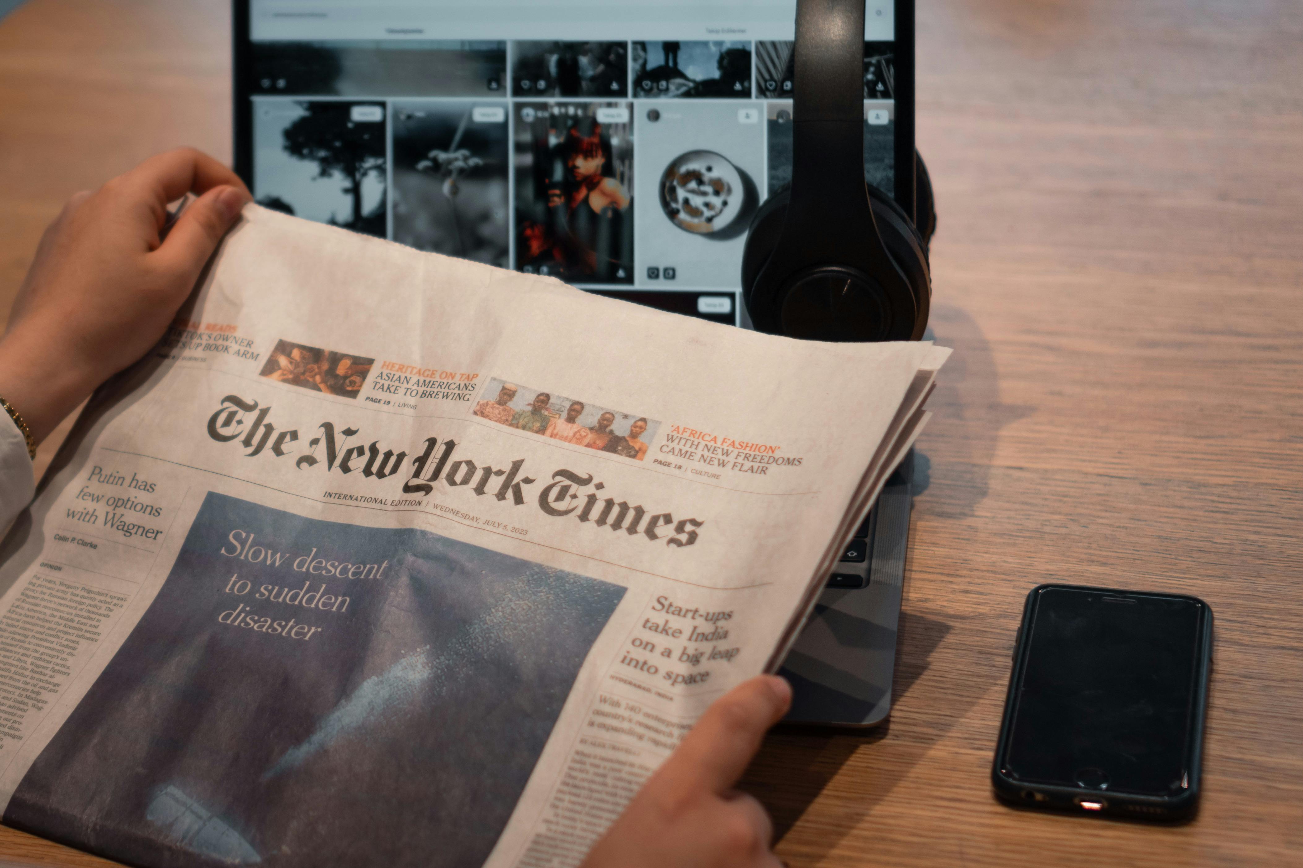 Hands Holding New York Times Newspaper · Free Stock Photo