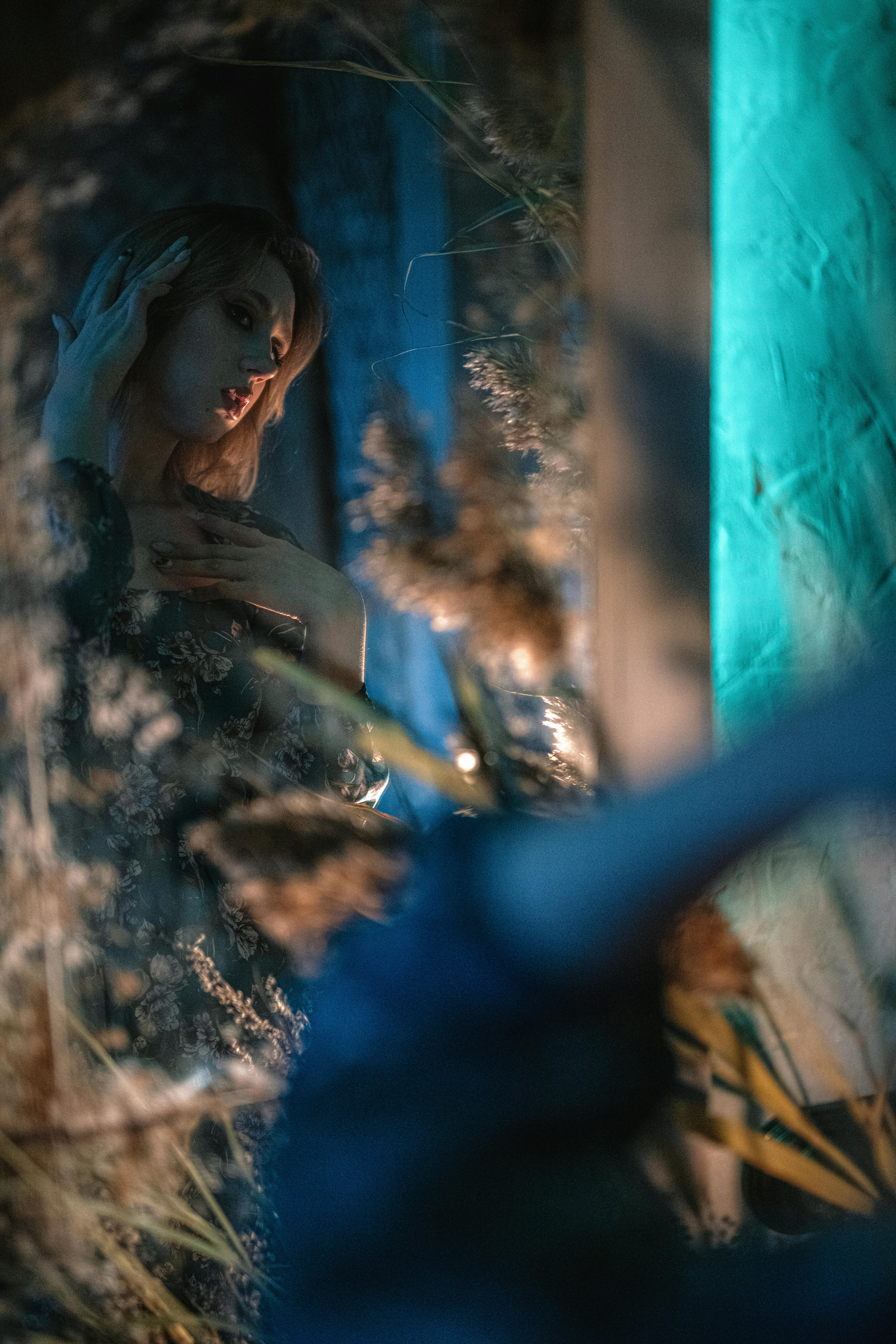 Woman Posing behind Plants · Free Stock Photo