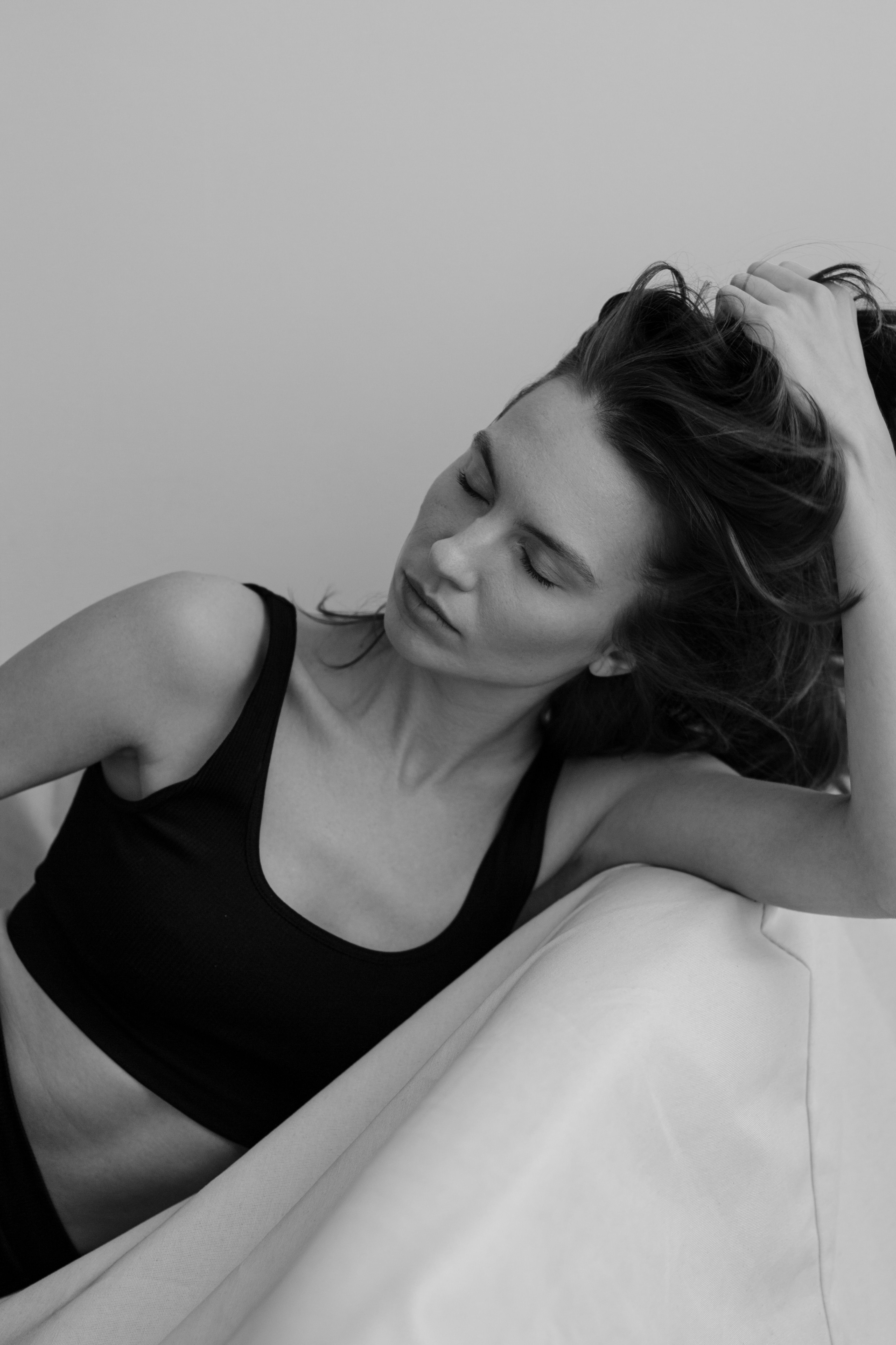Woman in Top Fixing Hair · Free Stock Photo