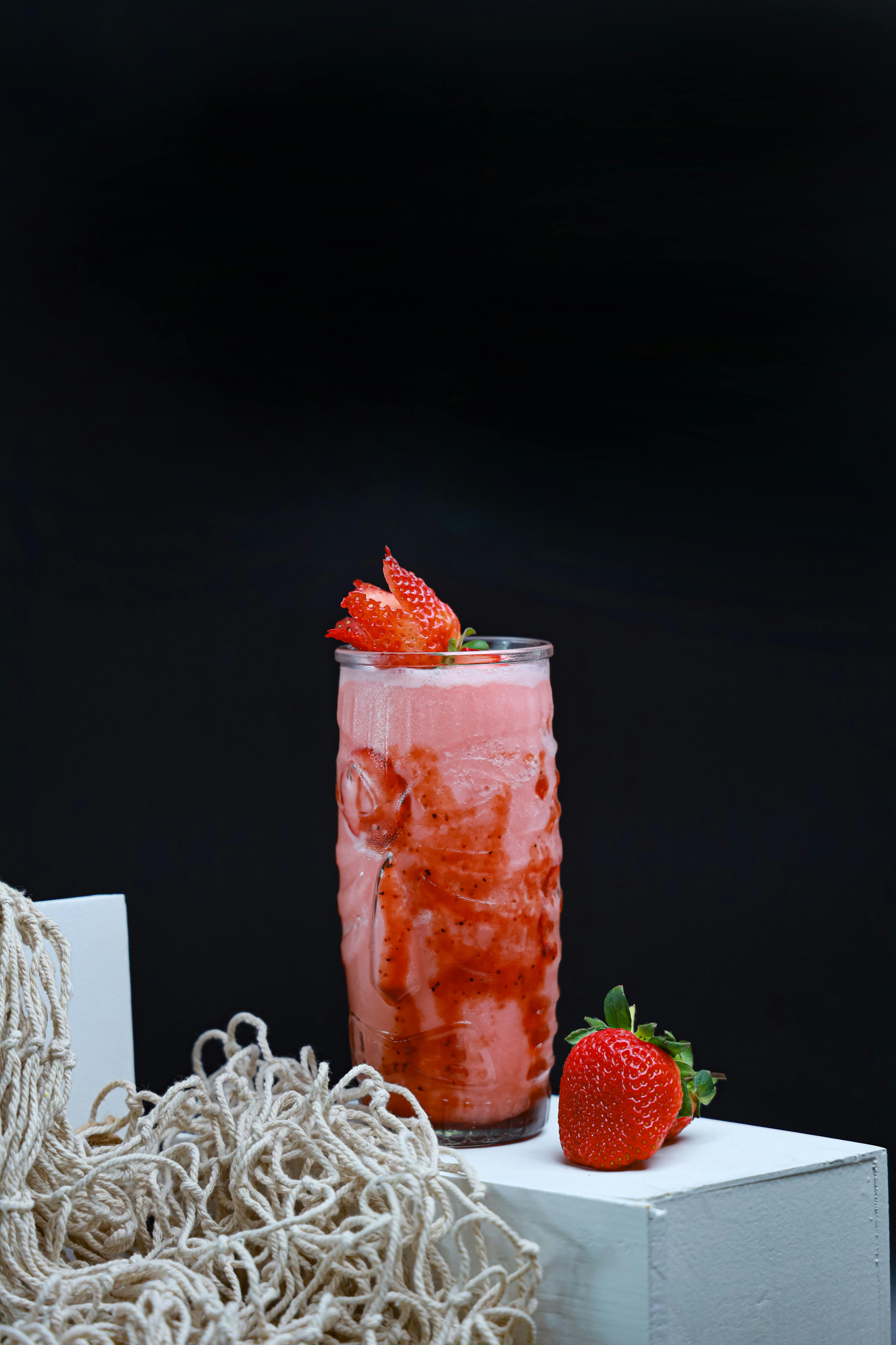 A strawberry drink with a straw and a piece of string · Free Stock Photo