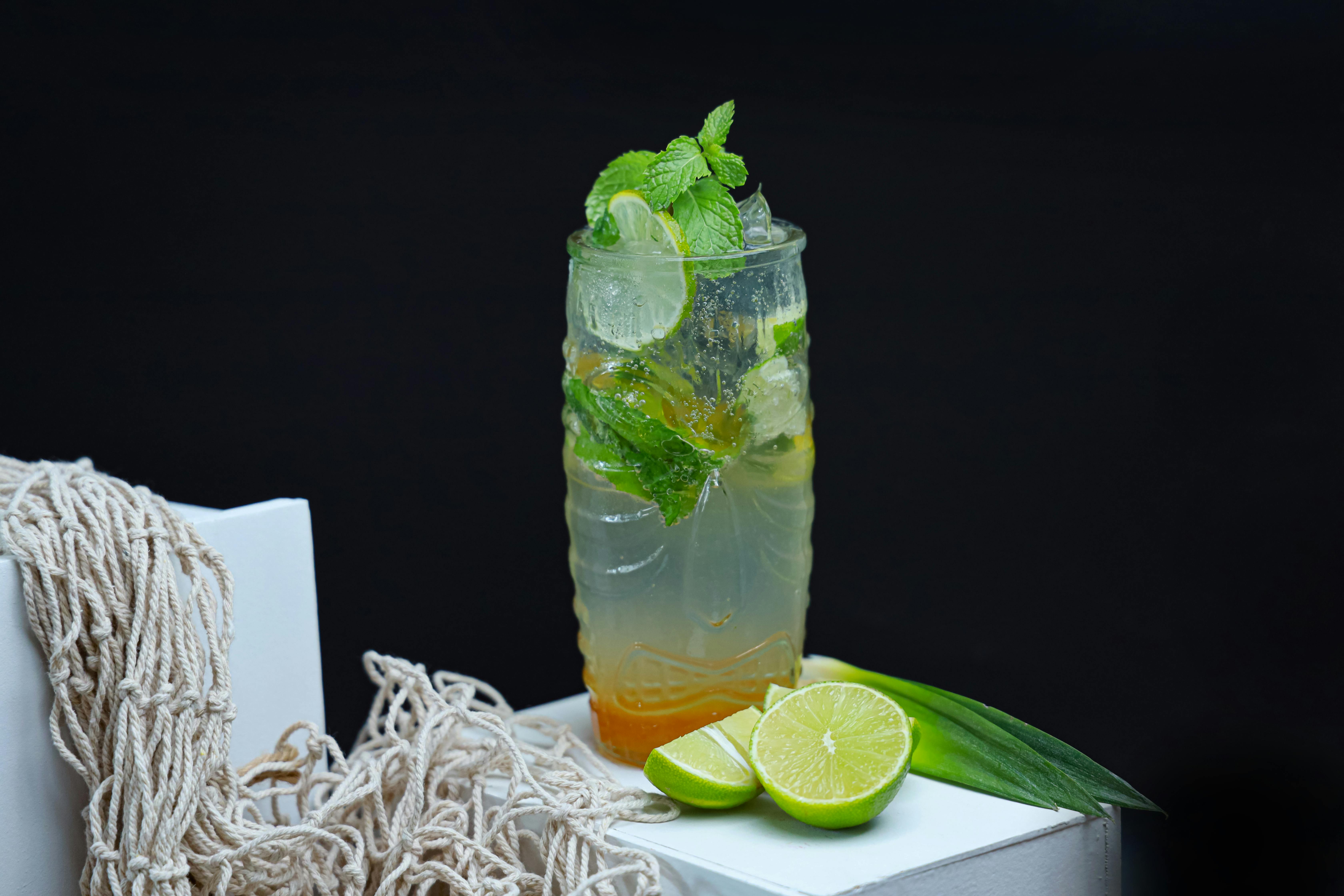 A glass of limeade with a lime slice and a piece of rope · Free Stock Photo