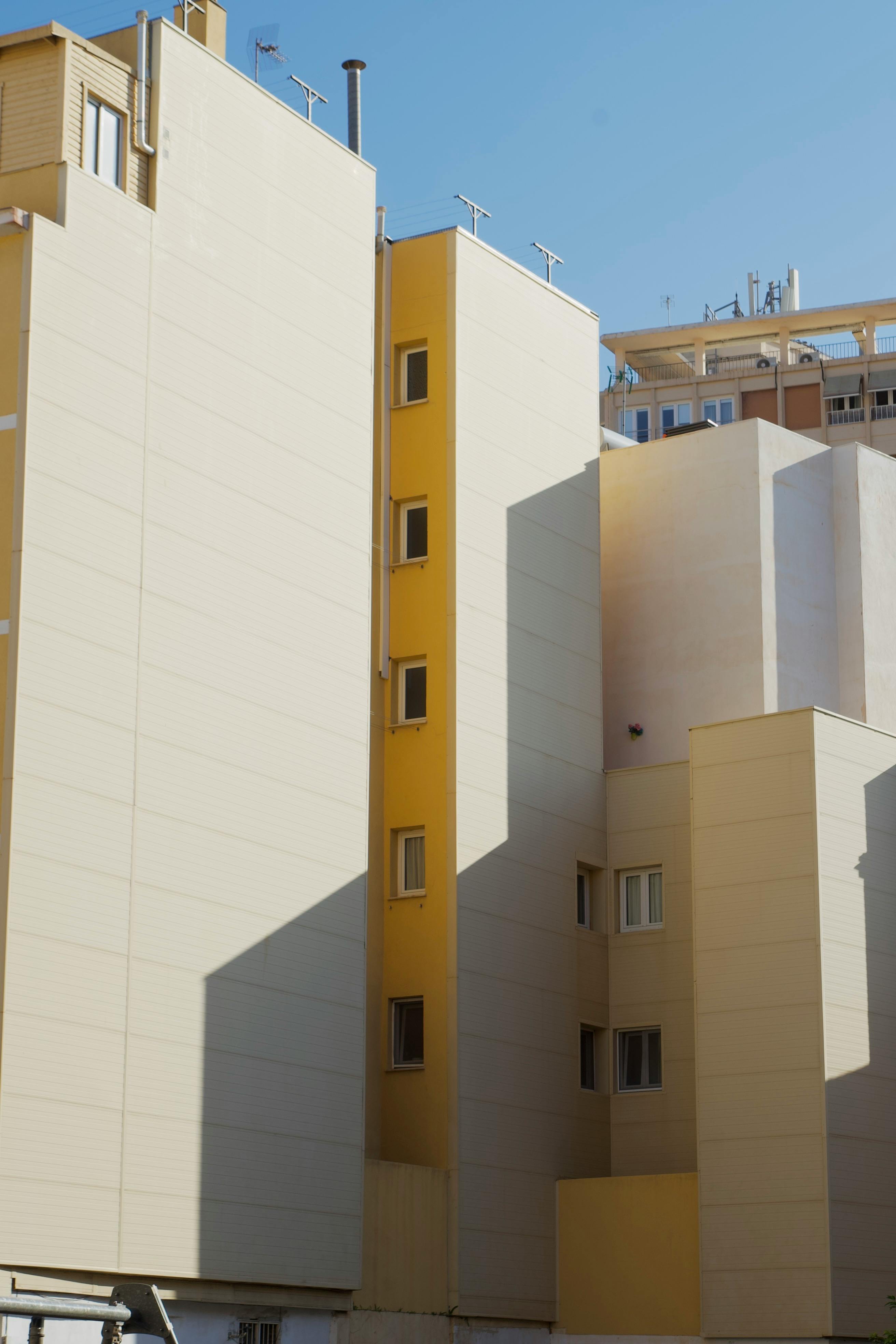 White Windowless Walls of an Apartment Building · Free Stock Photo