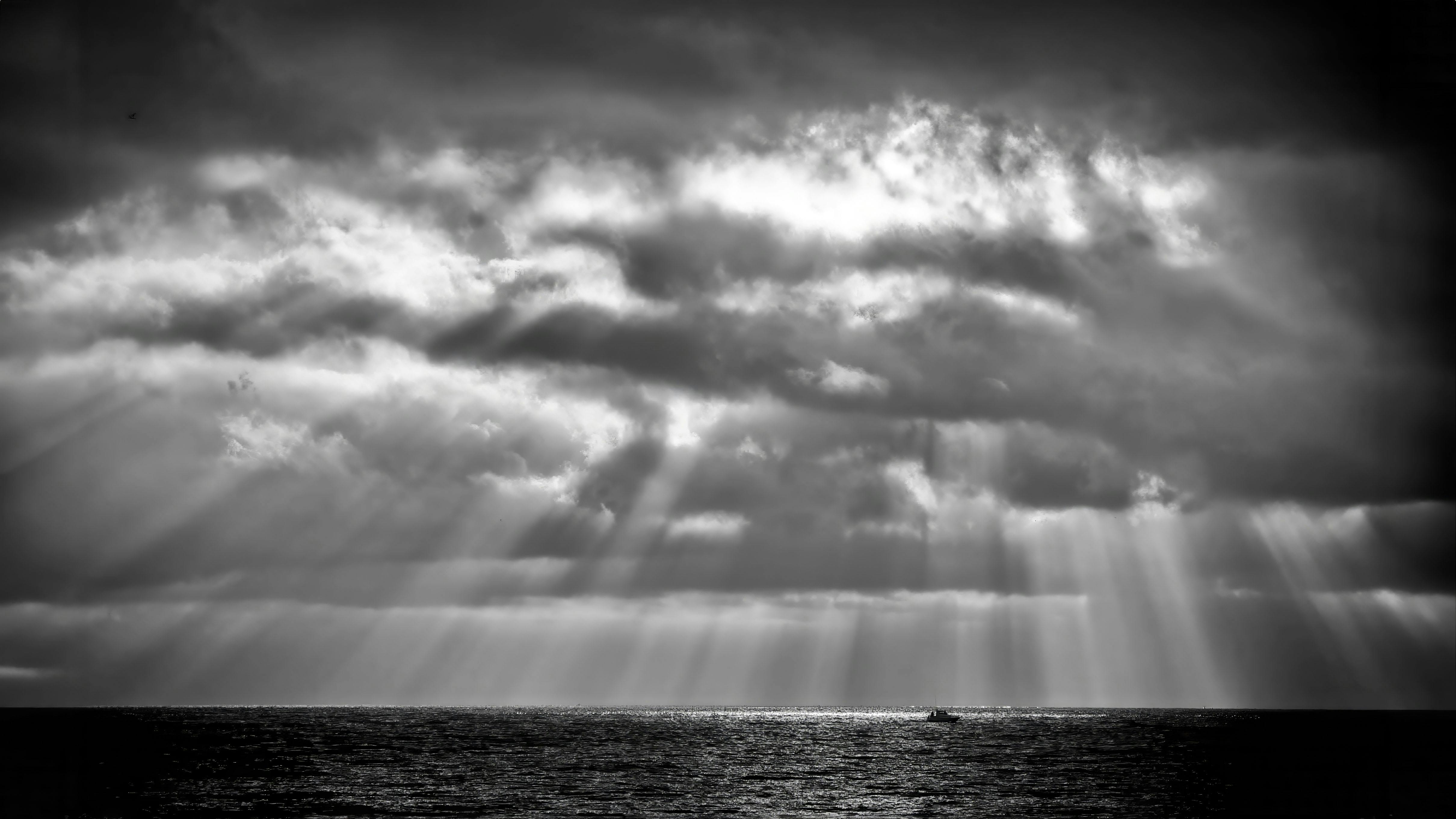 Sunbeams over Sea under Clouds in Black and White · Free Stock Photo