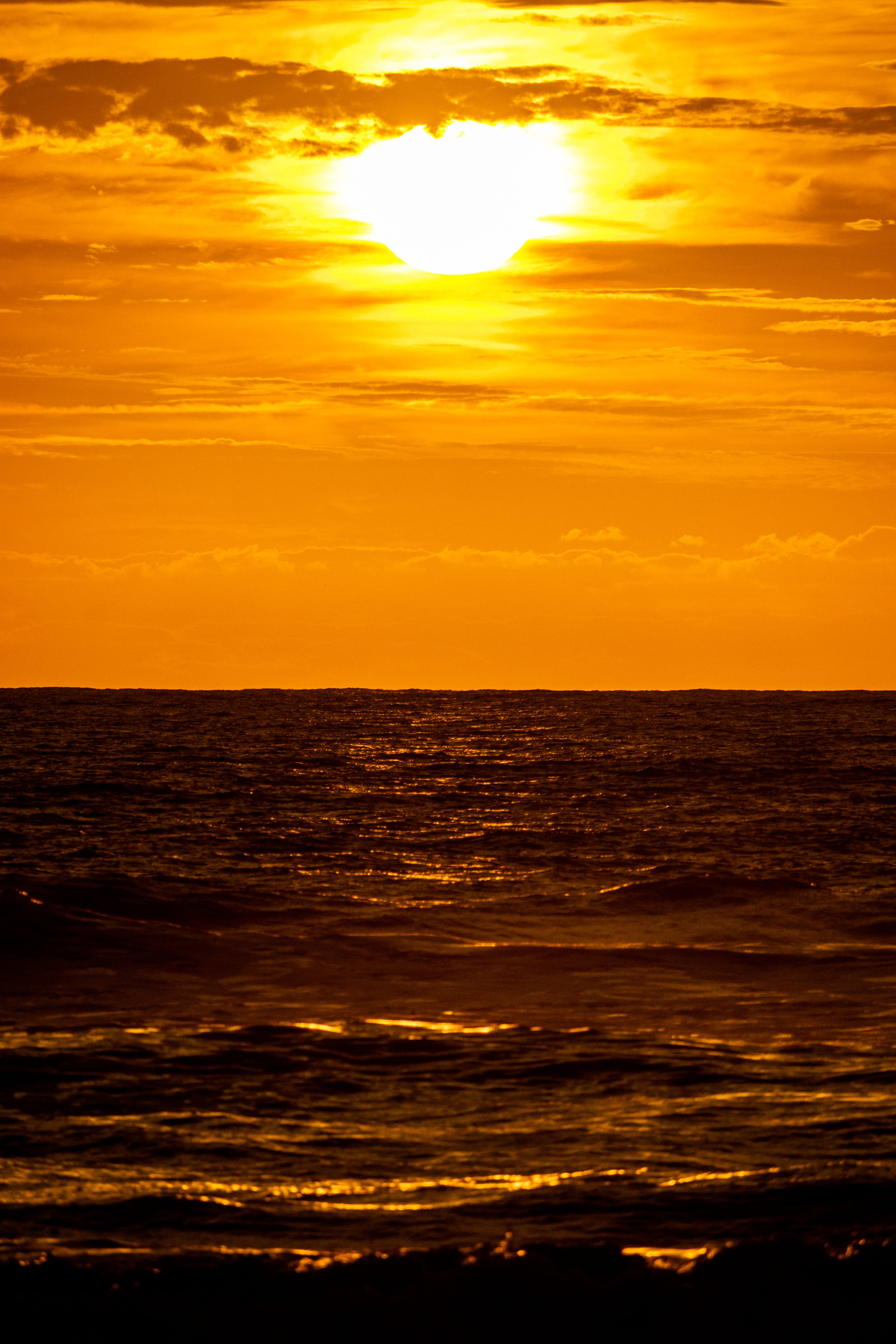 Photo of an Ocean Under an Orange Sky · Free Stock Photo