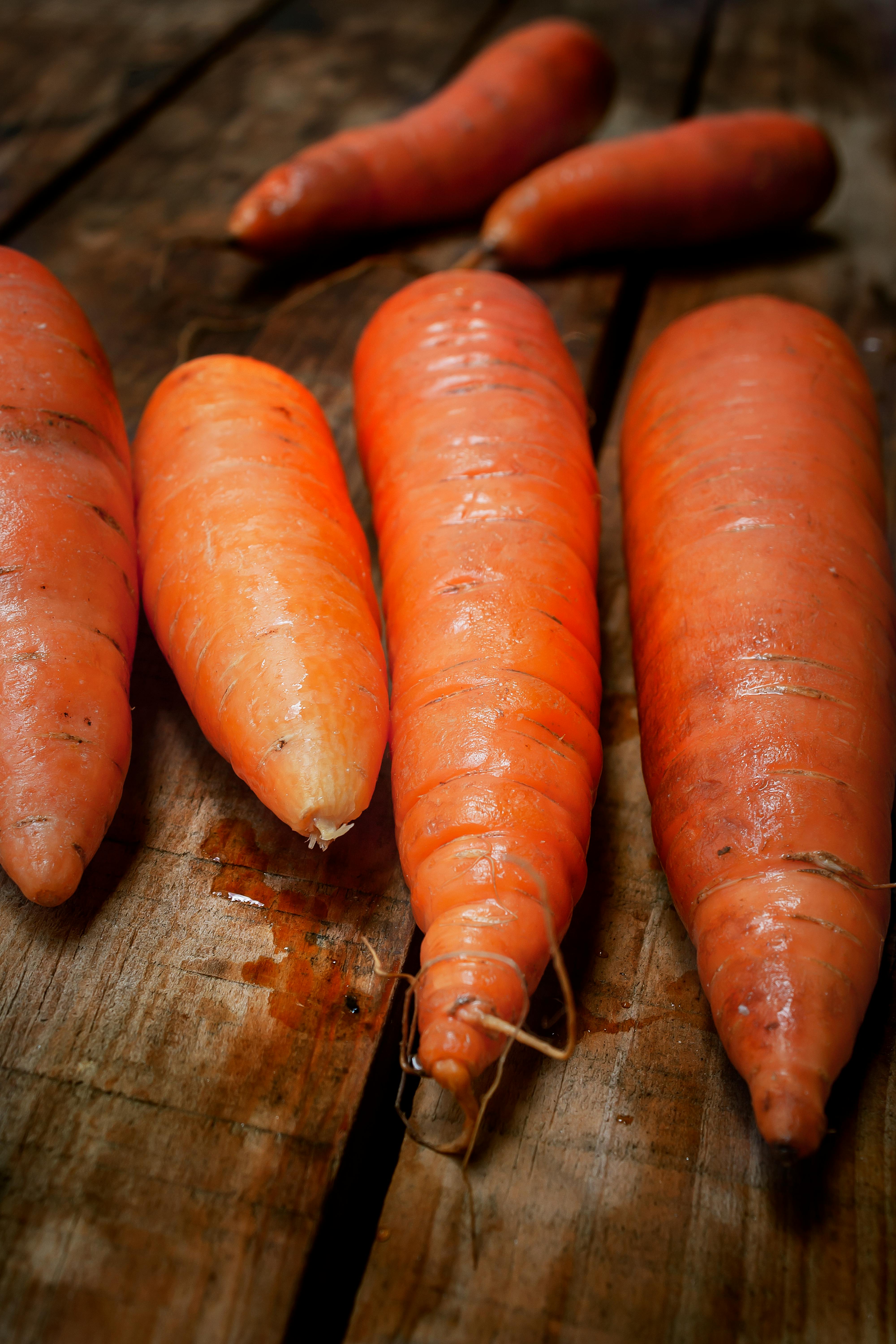 Washed Unscraped Carrots on a Wooden Table Top · Free Stock Photo
