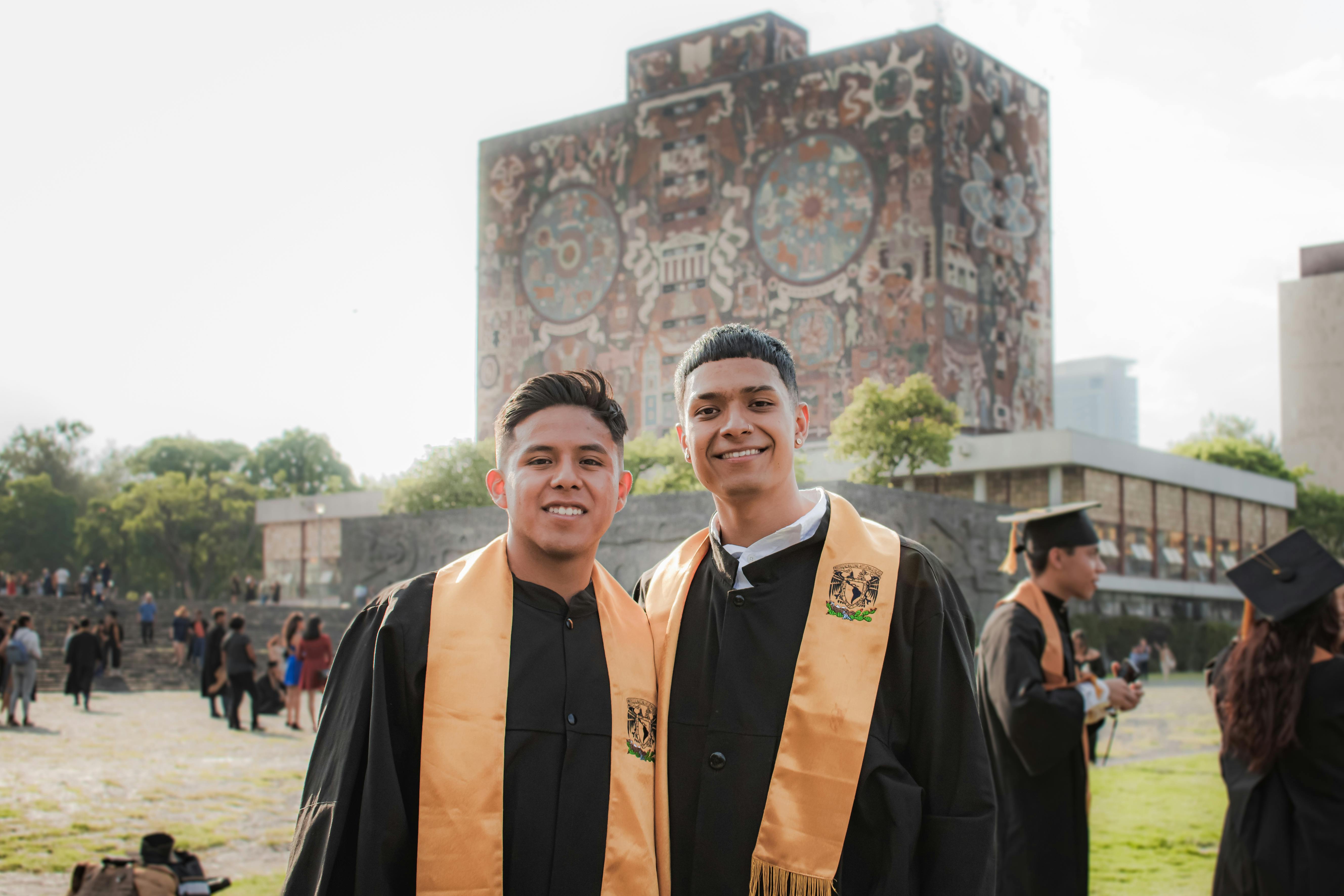 Graduates in Gowns Posing with UNAM Central Library behind · Free Stock ...