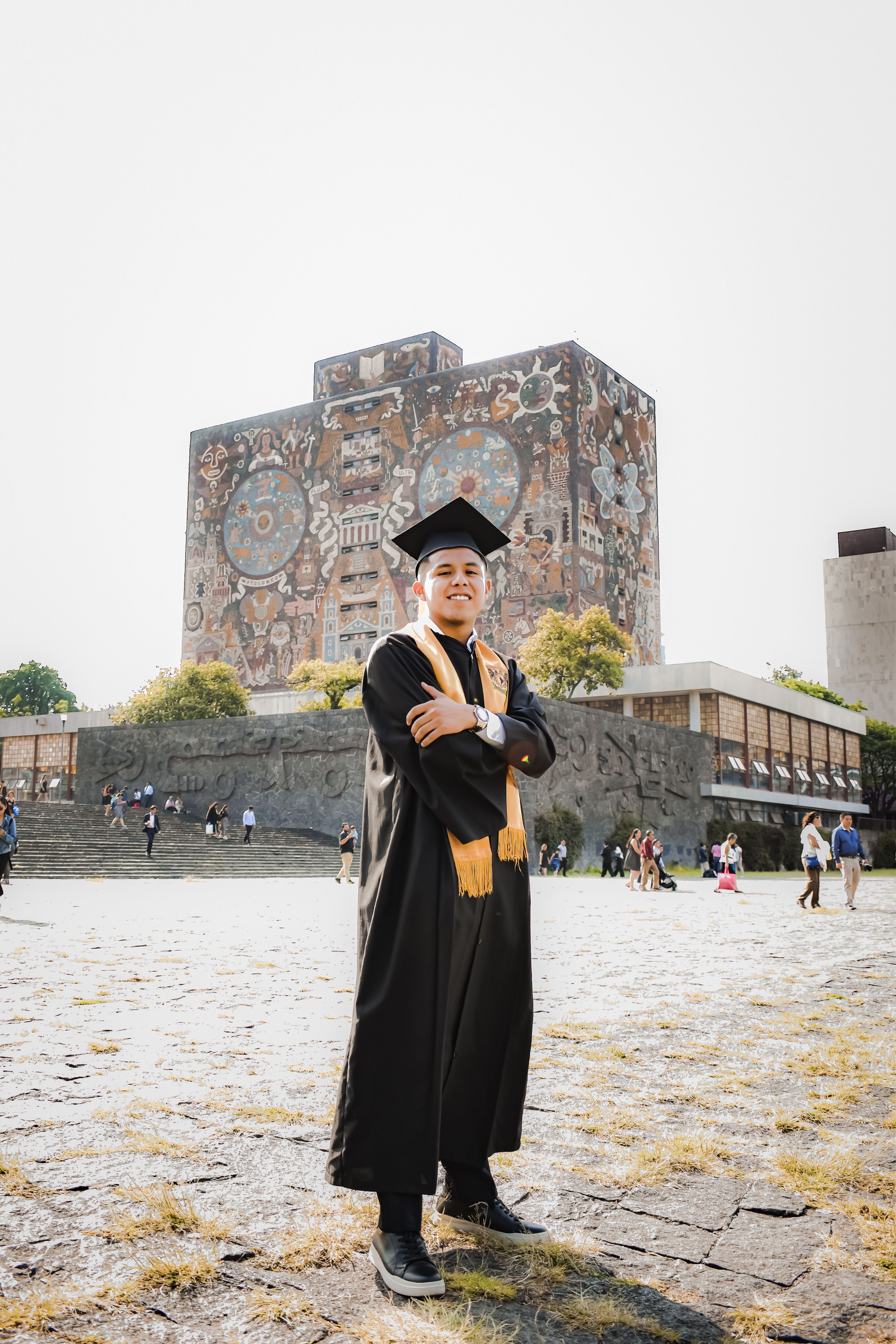 Graduate Posing with UNAM Building behind · Free Stock Photo